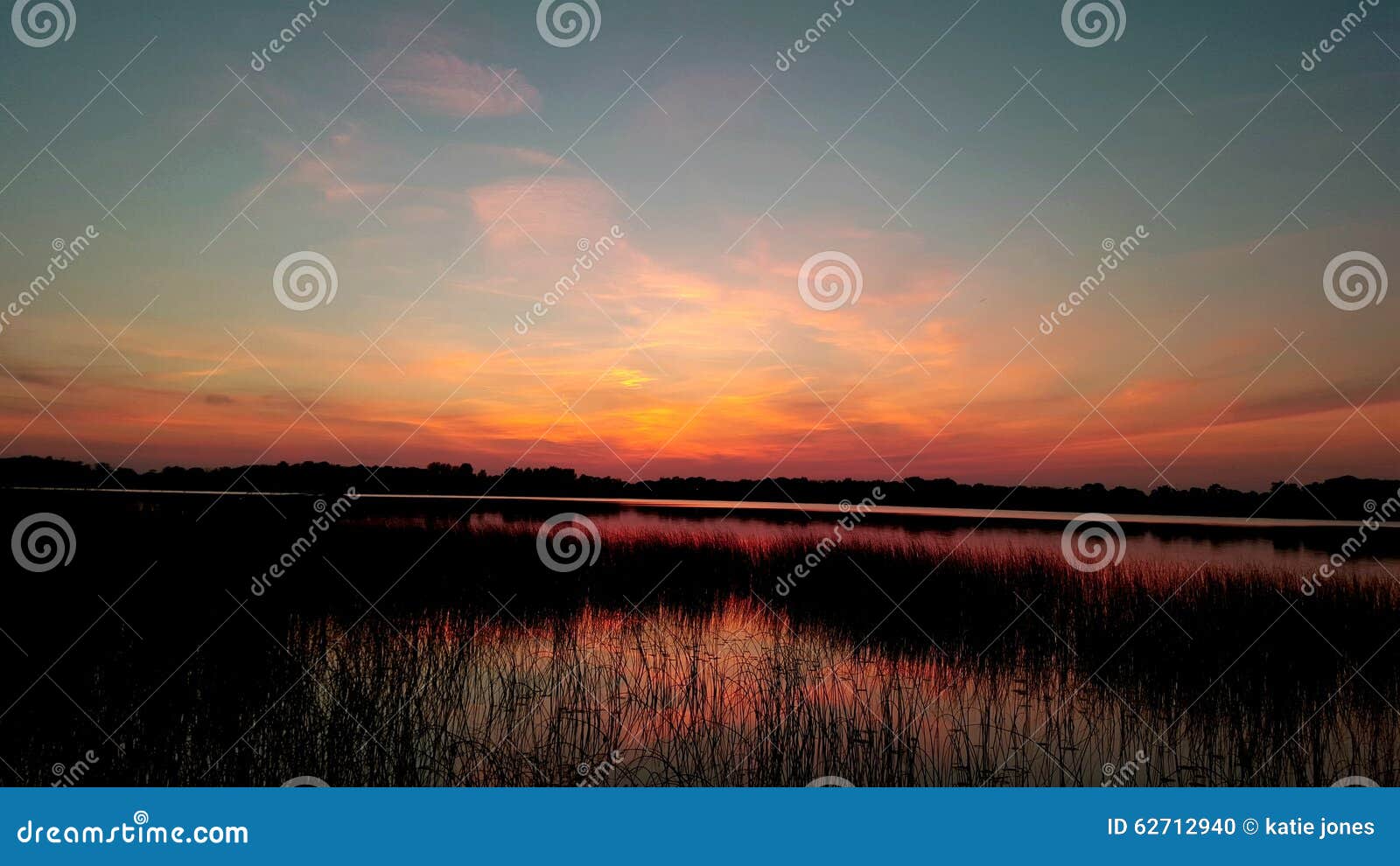 Peach and orange sunset stock photo. Image of reeds, water - 62712940