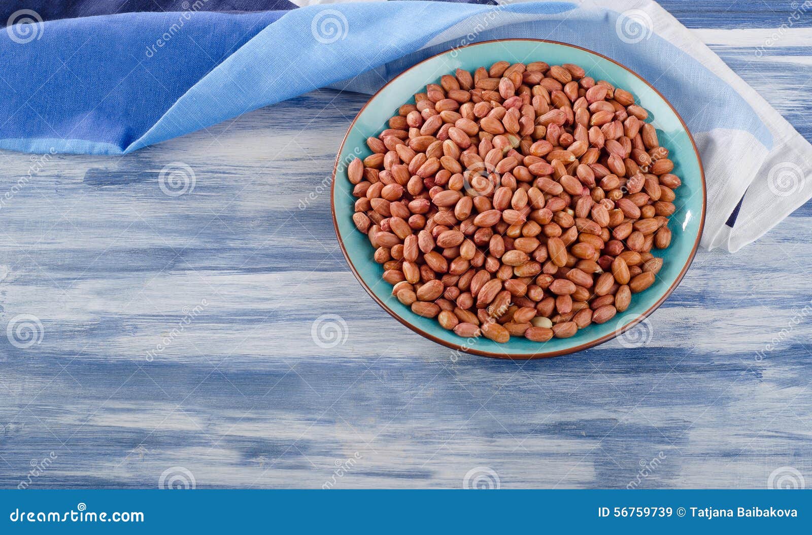 Peanuts on a blue plate . stock image. Image of healthy - 56759739