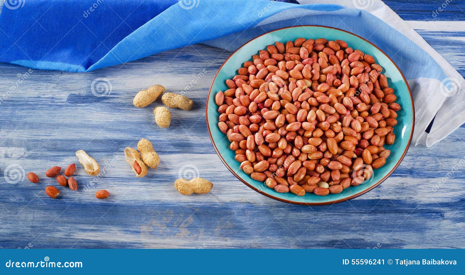 Peanuts on a blue table . stock image. Image of white - 55596241