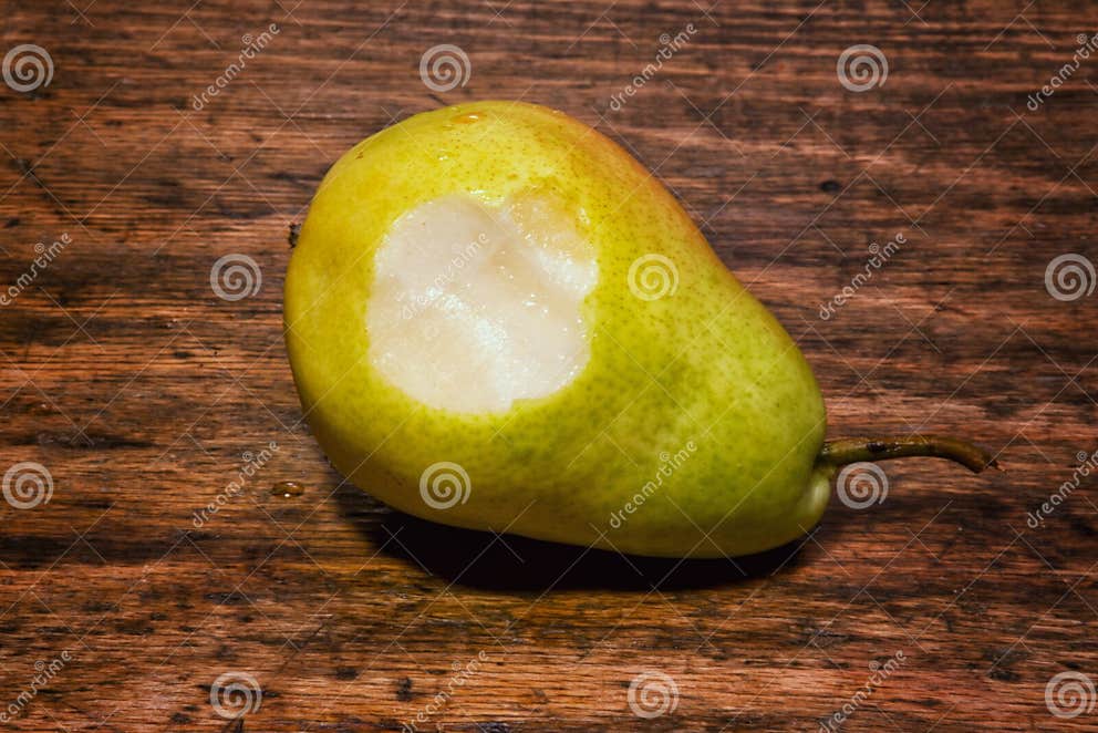 Pear with Bite Mark on Rustic Wooden Table Stock Image - Image of ...