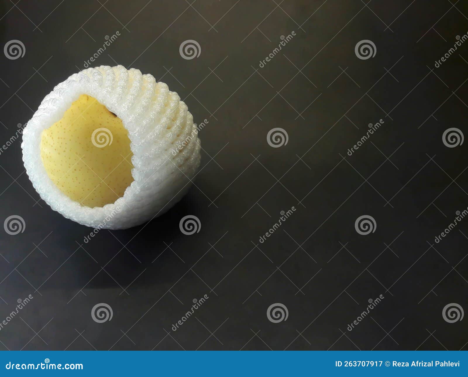 Pear Wrapped in Foam Net with Black Background Stock Image - Image of ...