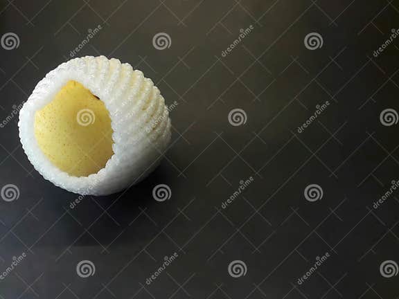 Pear Wrapped in Foam Net with Black Background Stock Image - Image of ...