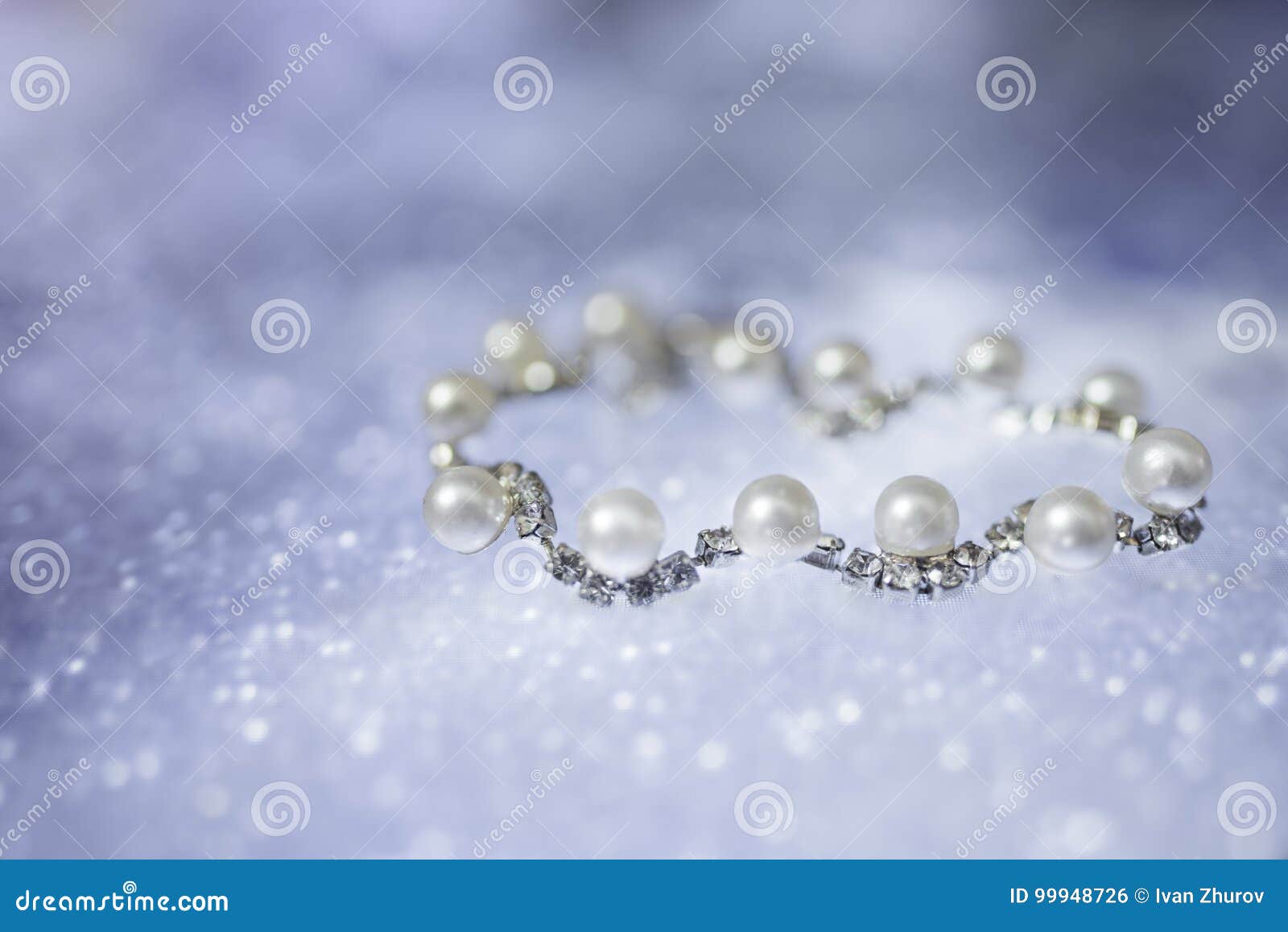 Pearl Silver Bracelet with Diamonds on a Blurry Blue Background Stock ...