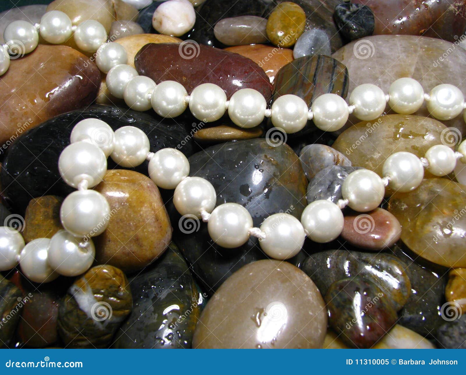 Pearls over river rocks stock image. Image of fashion - 11310005