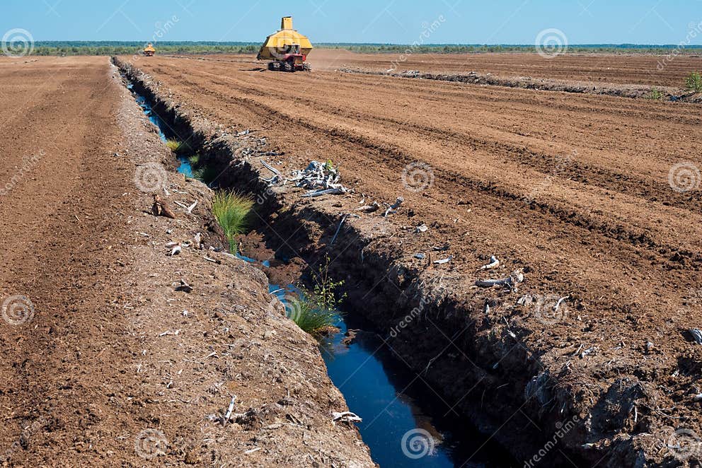 Peat extraction process stock photo. Image of brown - 127964396