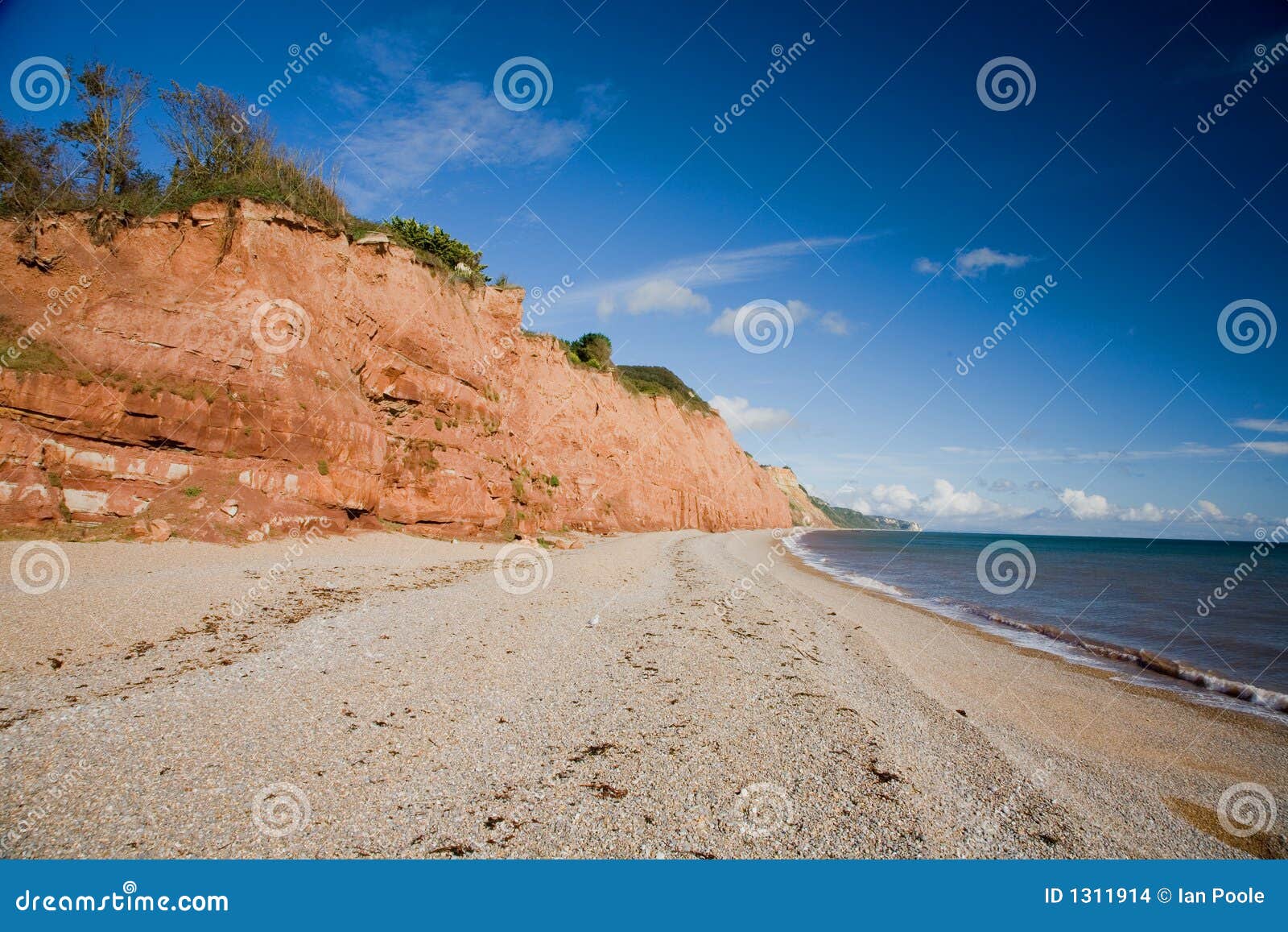 Pebble Beach and Sandstone Cliffs Stock Photo - Image of waves ...