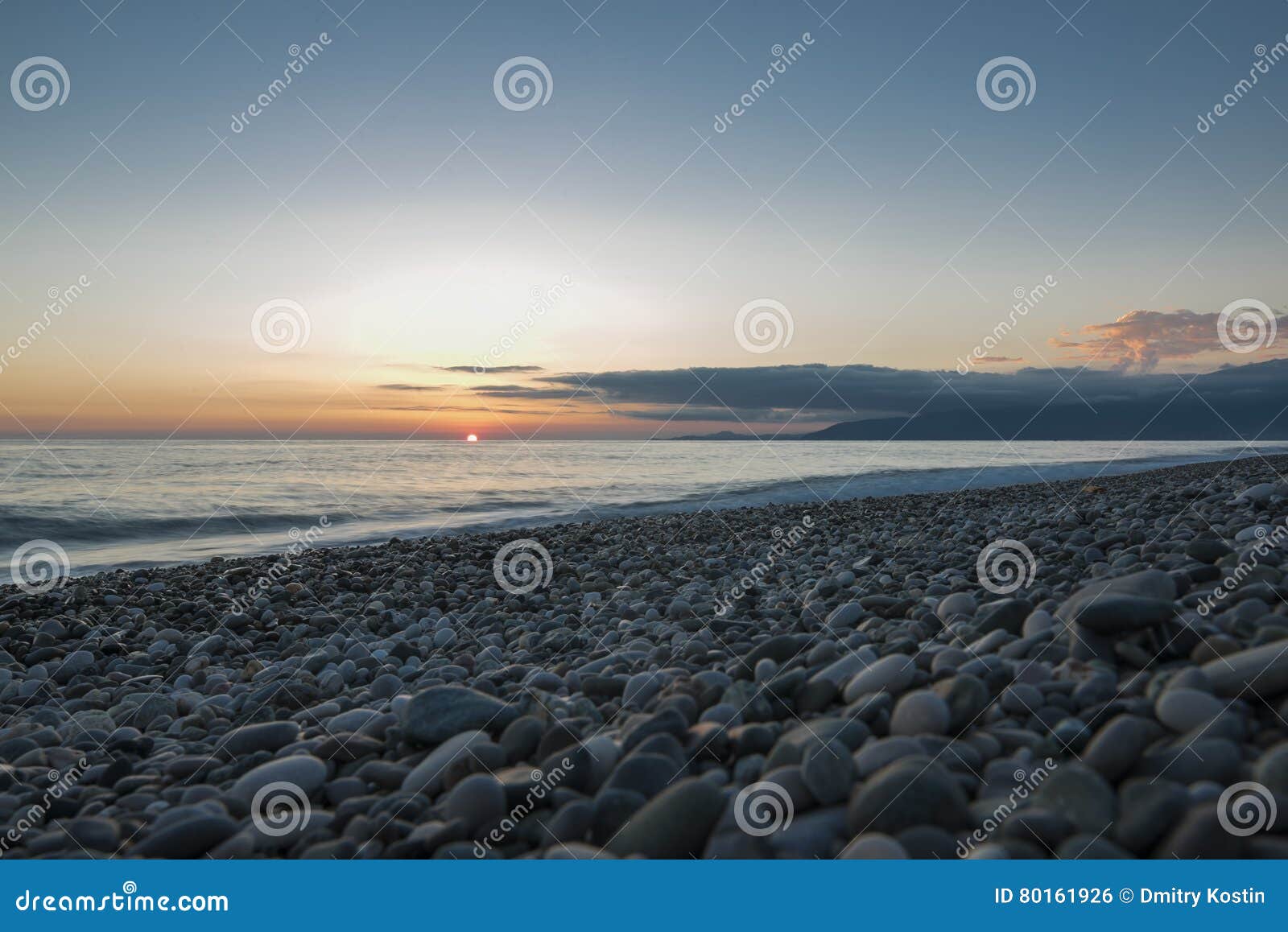 Pebble beach at sunset stock photo. Image of reflection - 80161926
