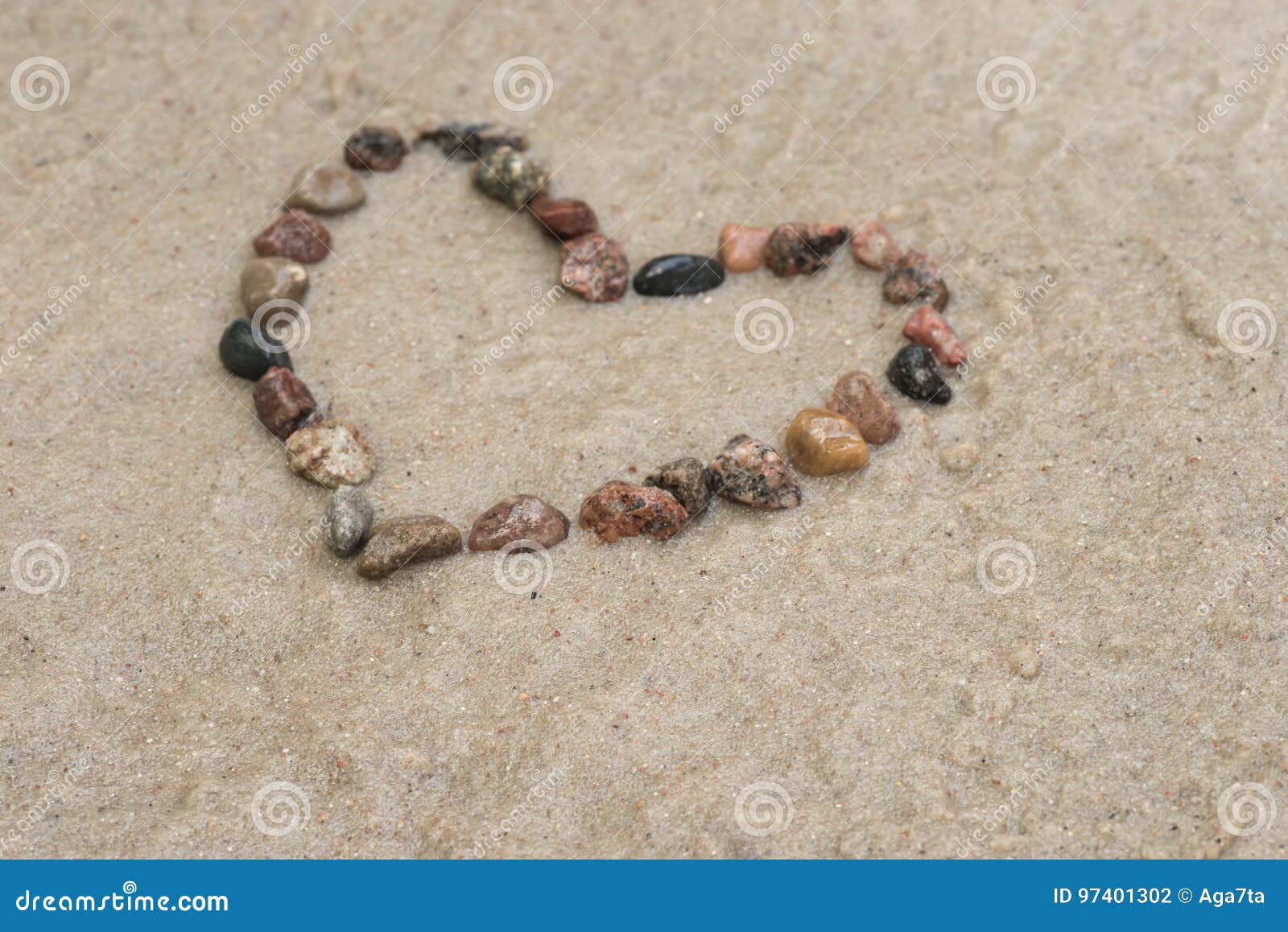 Pebble heart shape on sand stock photo. Image of ocean - 97401302