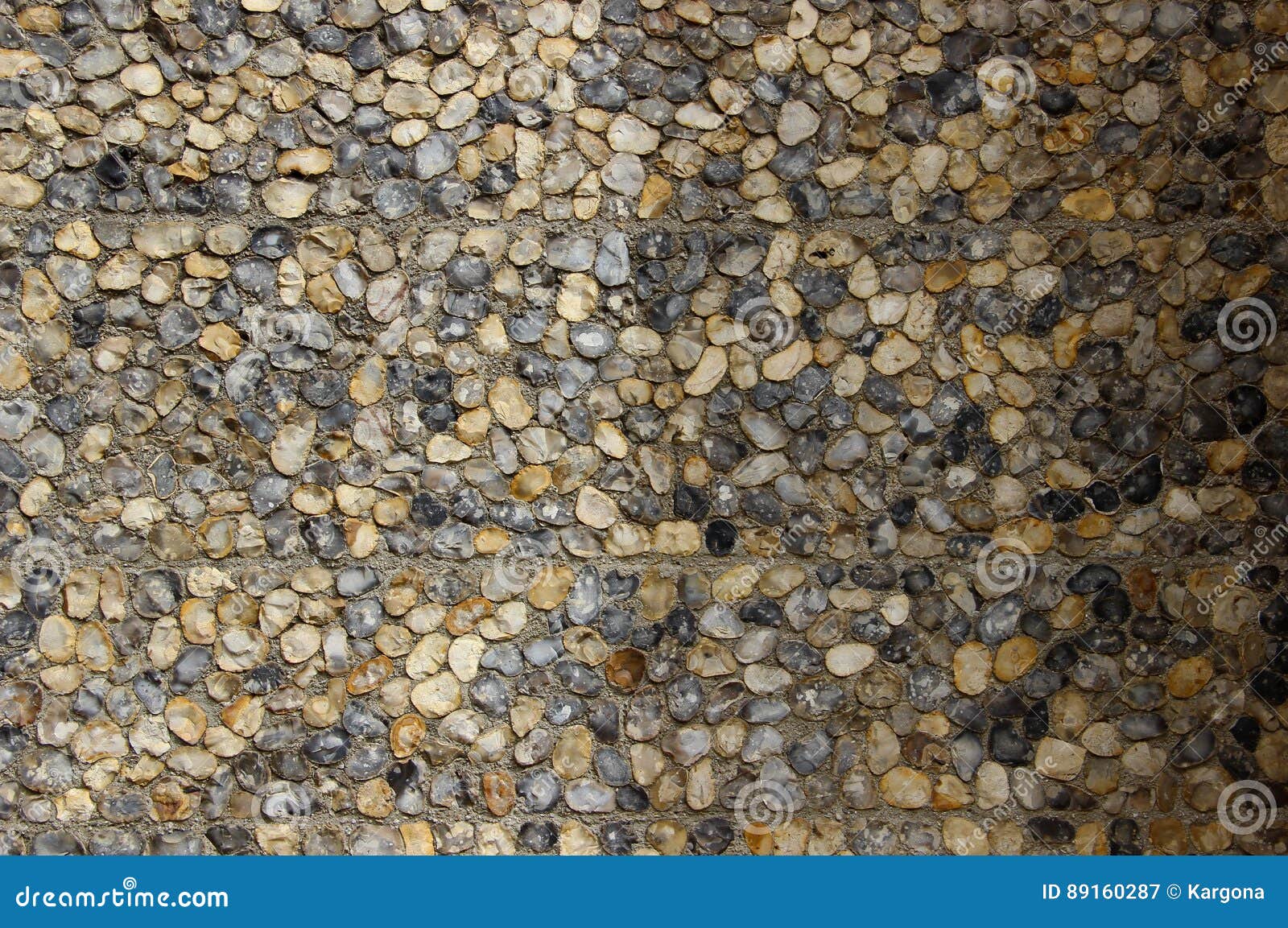 A Pebble Stone Wall Made of Natural Stones with One Half of it in ...