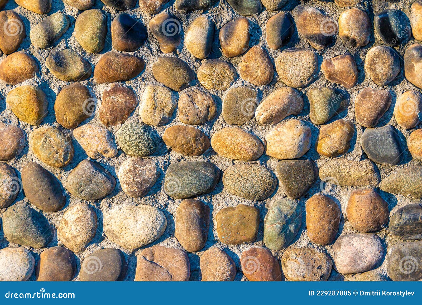 Pebble Stones Lie in Rows Partially Pressed into the Main Surface of ...
