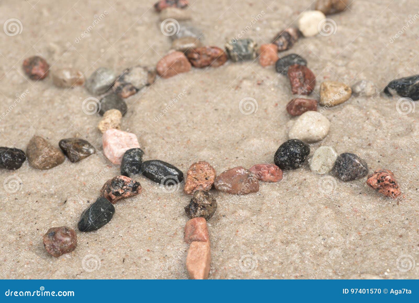 Pebble sun sign on sand stock photo. Image of ocean, shape - 97401570