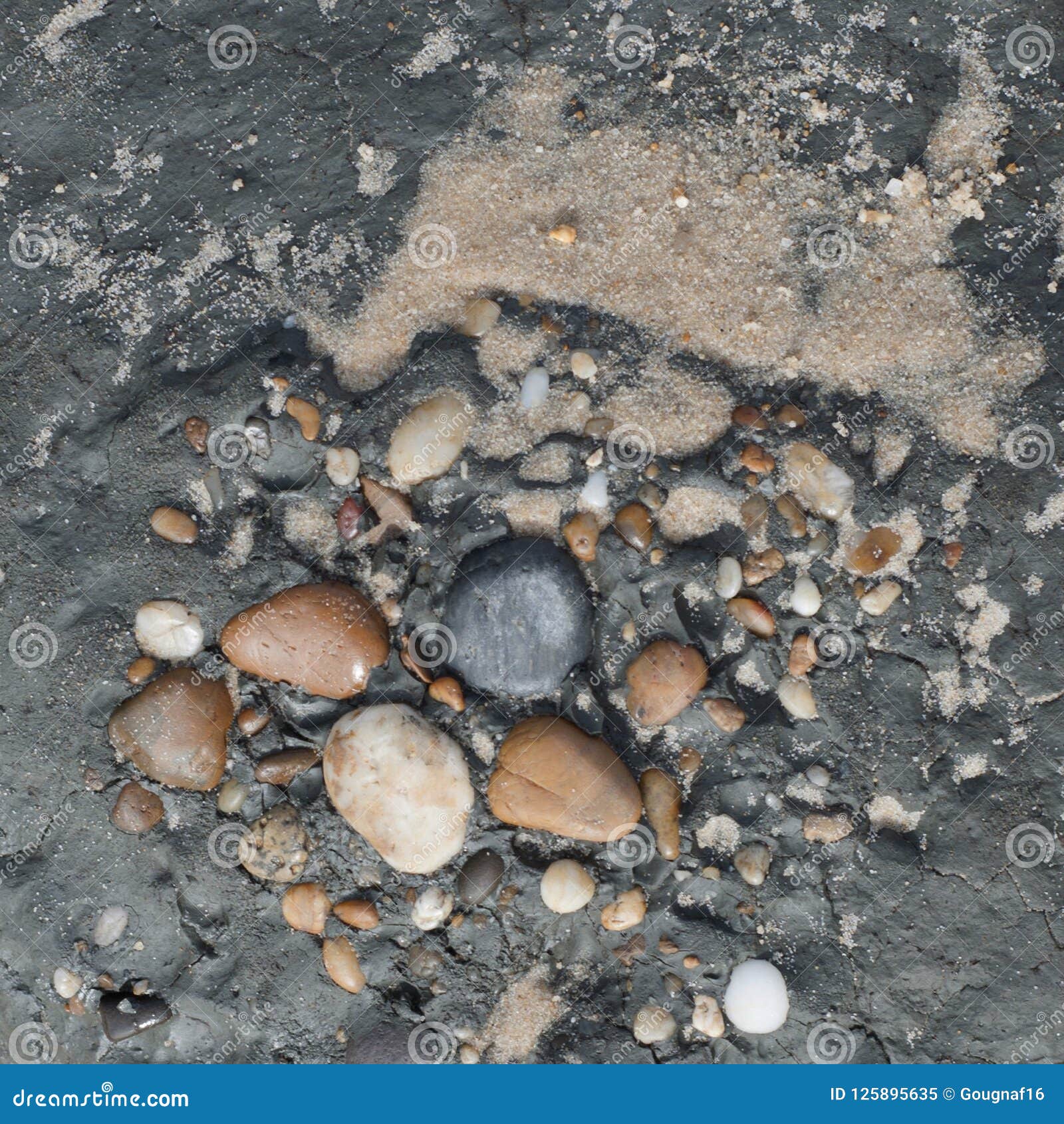 Pebbles embedded in rock. stock image. Image of beach - 125895635