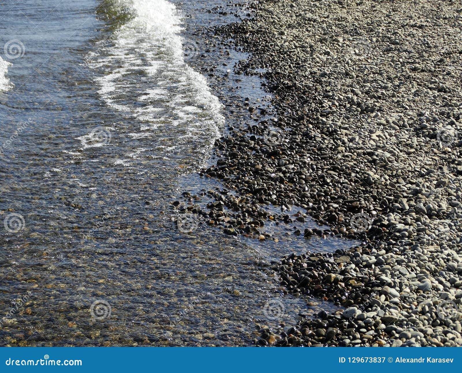 Pebbles on the river Bank stock image. Image of stones - 129673837