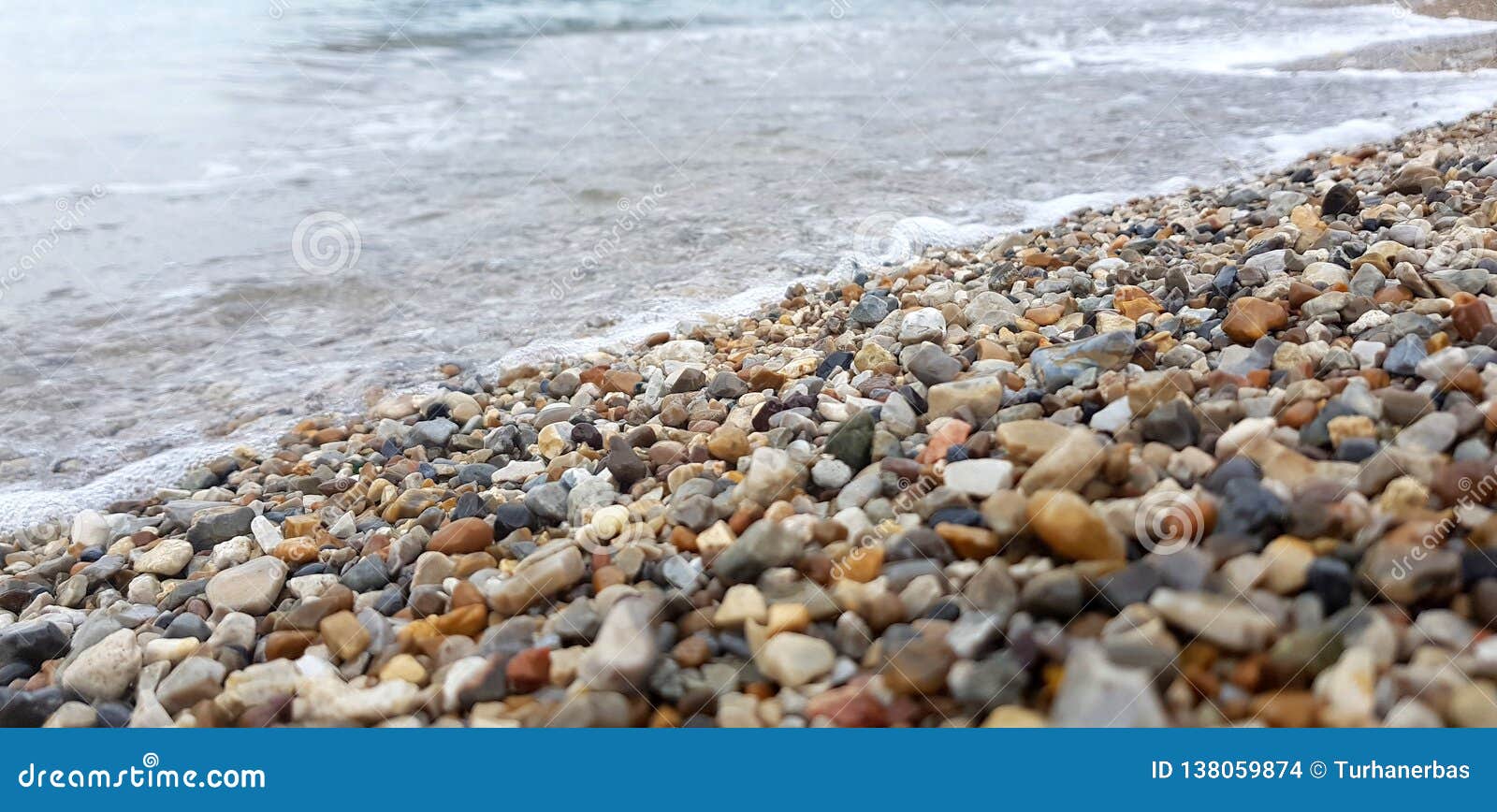 Pebbles among the Sand on Seashore Stock Photo - Image of blury, ocean ...