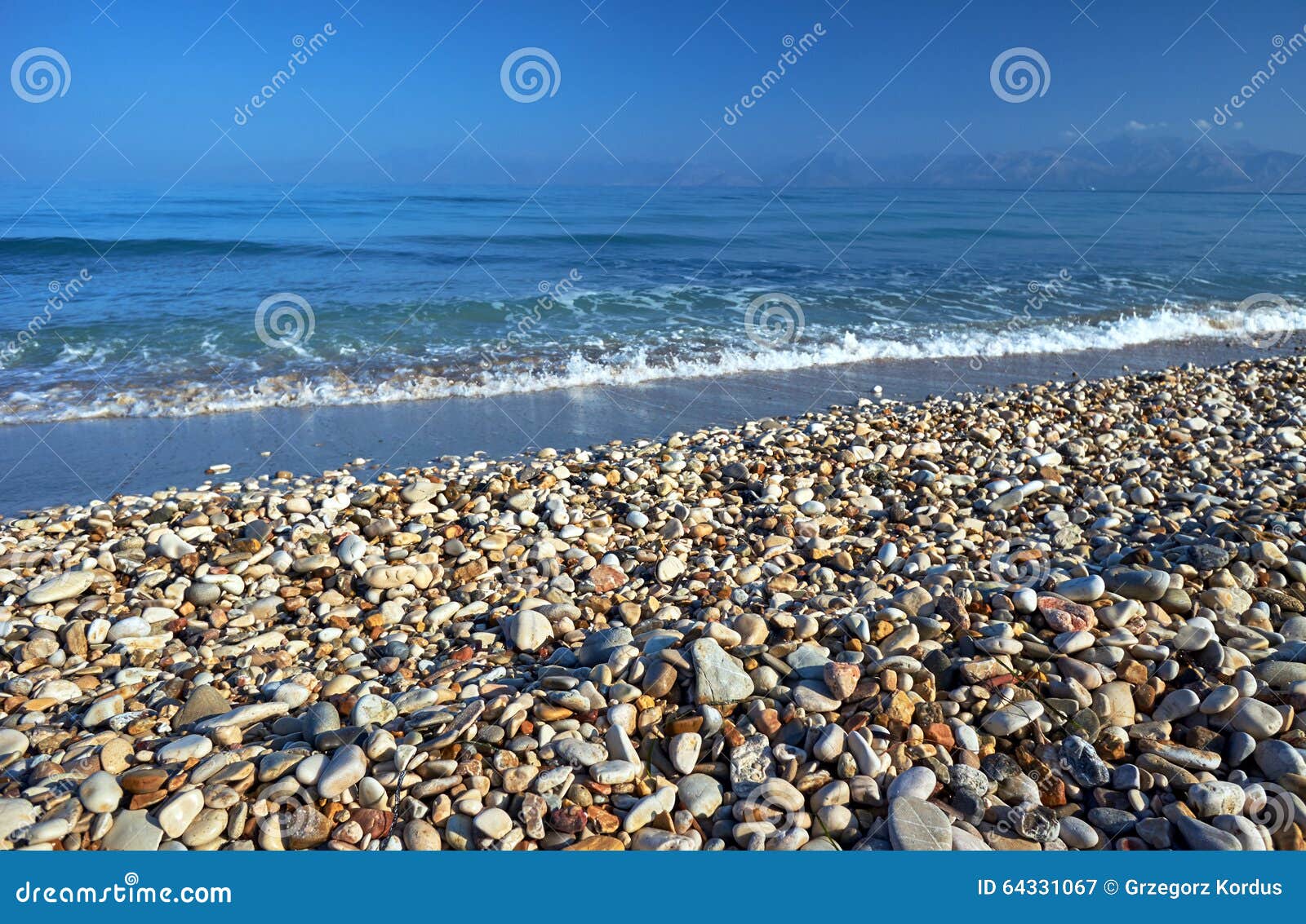 Pebbles on a sandy beach stock image. Image of beach - 64331067