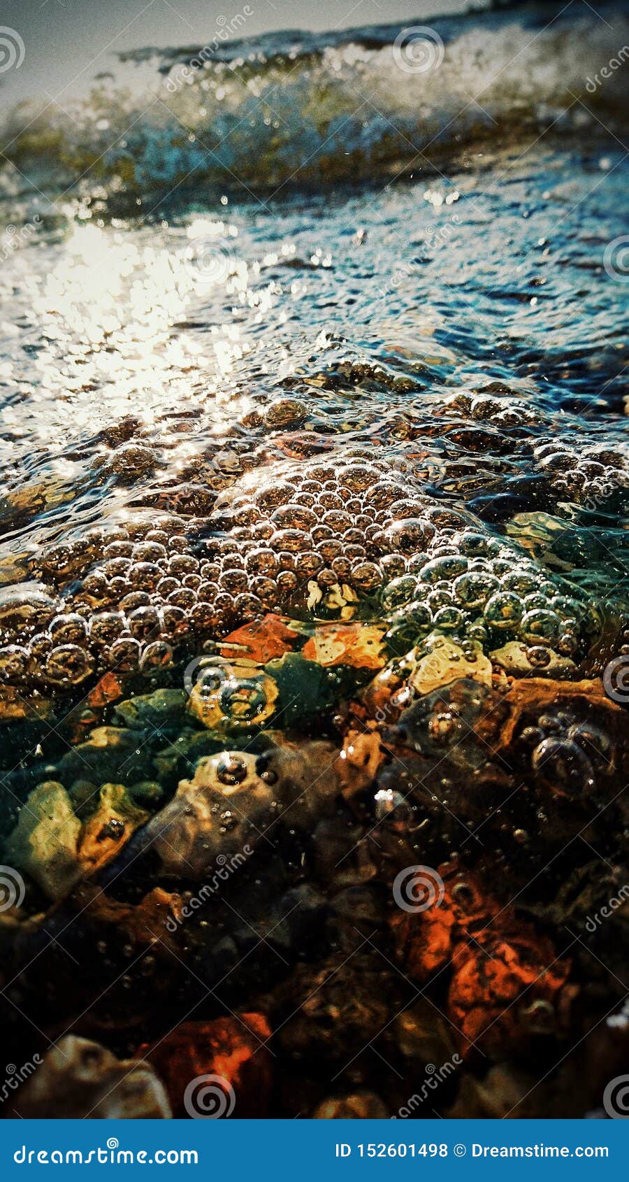 Pebbles under water stock photo. Image of reflection - 152601498