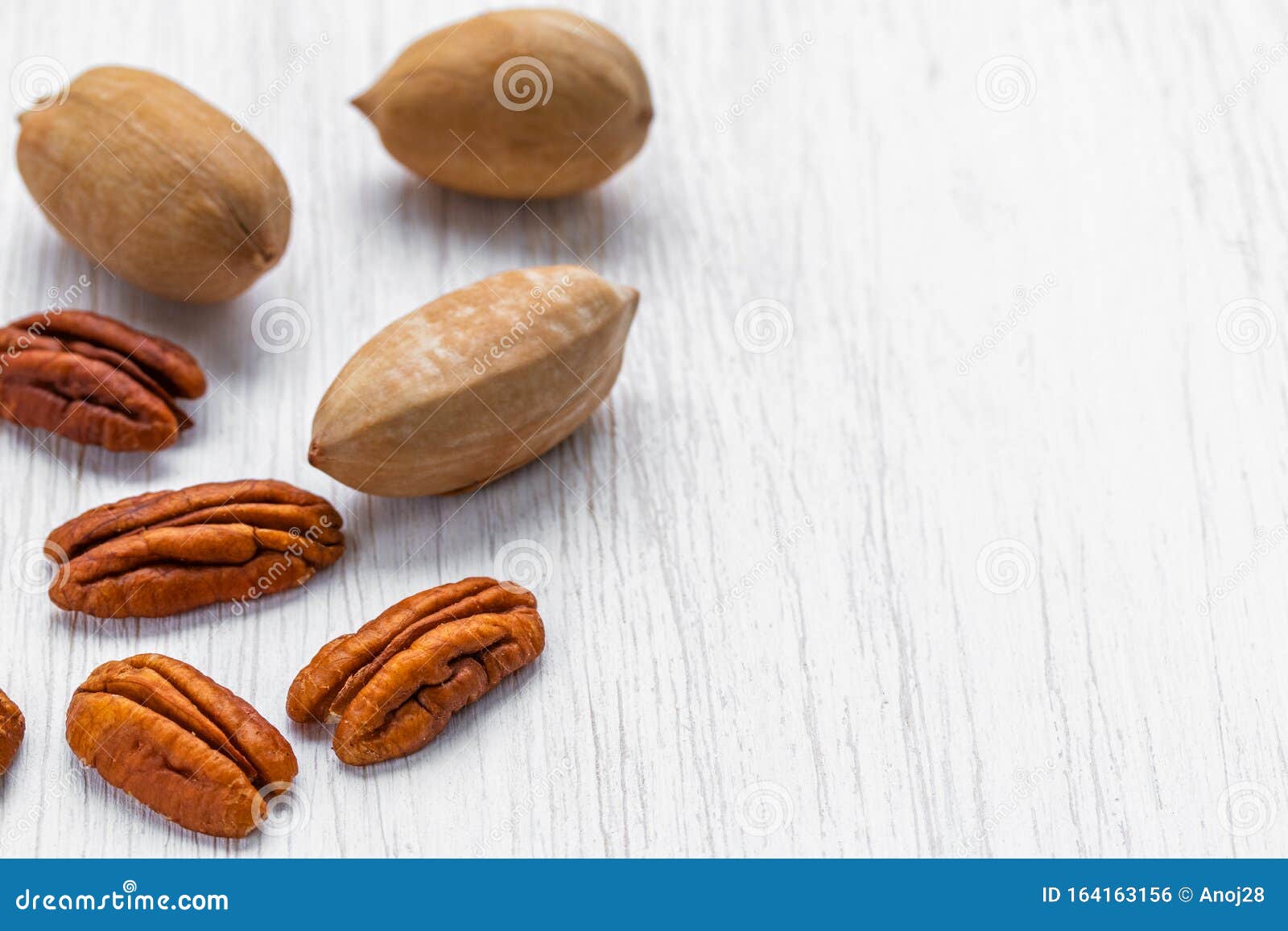 Pecans Peeled and in Shell Lying on a White Wooden Surface Stock Photo ...