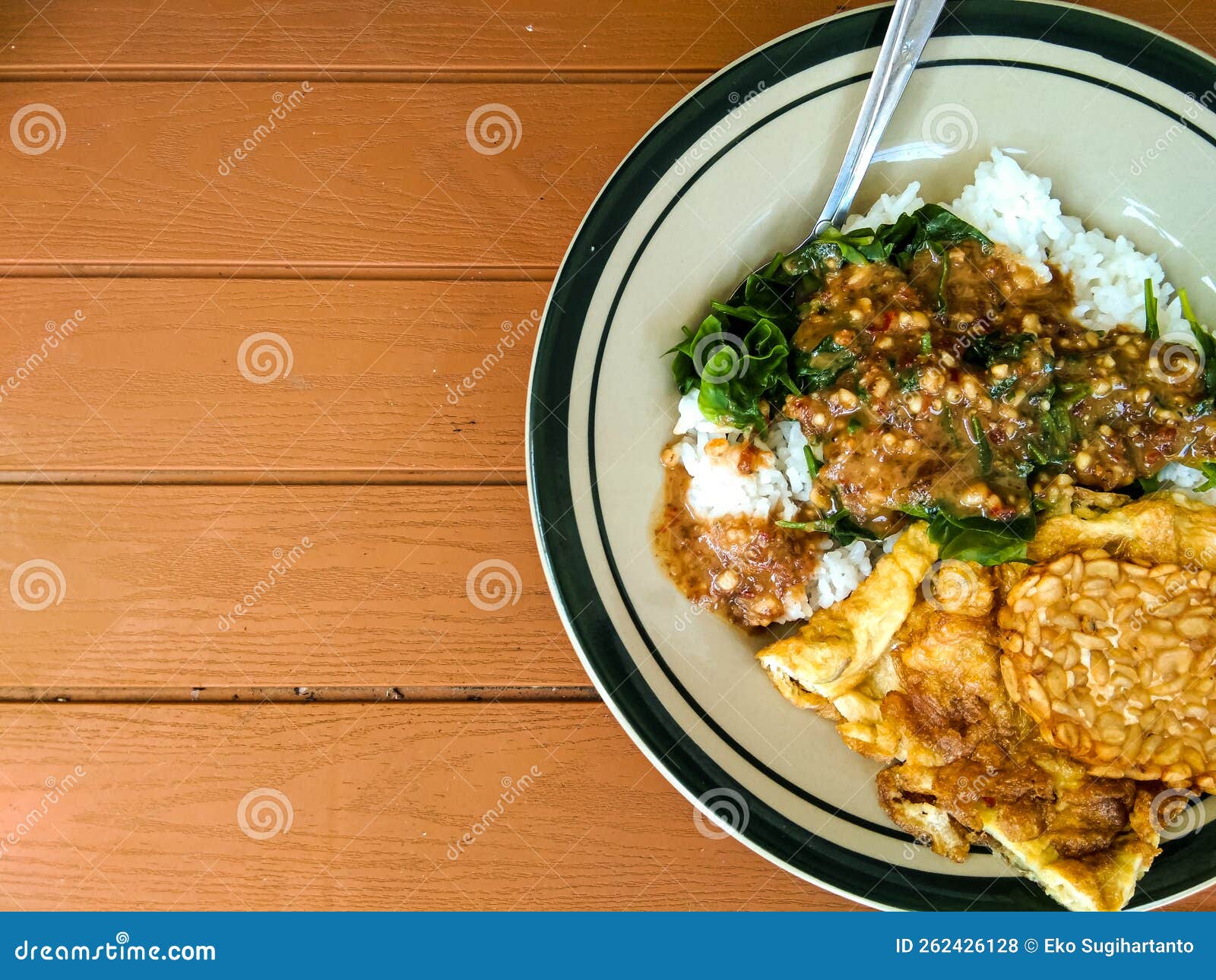 Pecel Rice with Side Dishes of Tempeh and Scrambled Eggs Stock Photo ...