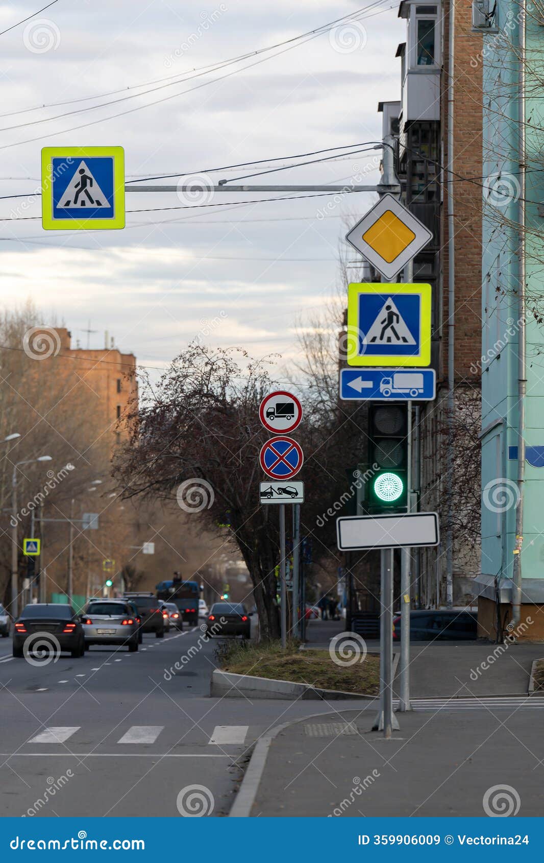 Pedestrian Crossing Signs on a Traffic Light Stand at an Intersection ...