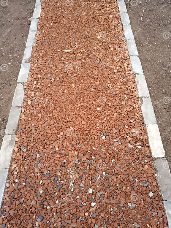 The Pedestrian Path is Lined with White Bricks and Covered with Small ...