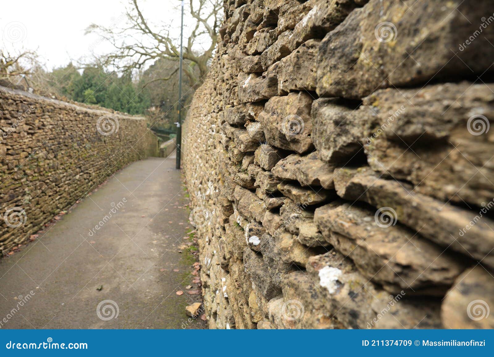 Pedestrian Walkway with Old Stone Wall in UK Stock Image - Image of ...