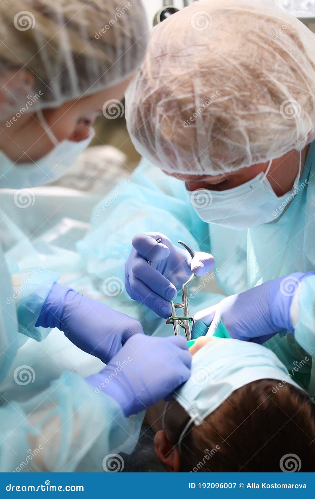Pediatric Dentist and Assistant during Surgery Under General Anesthesia ...
