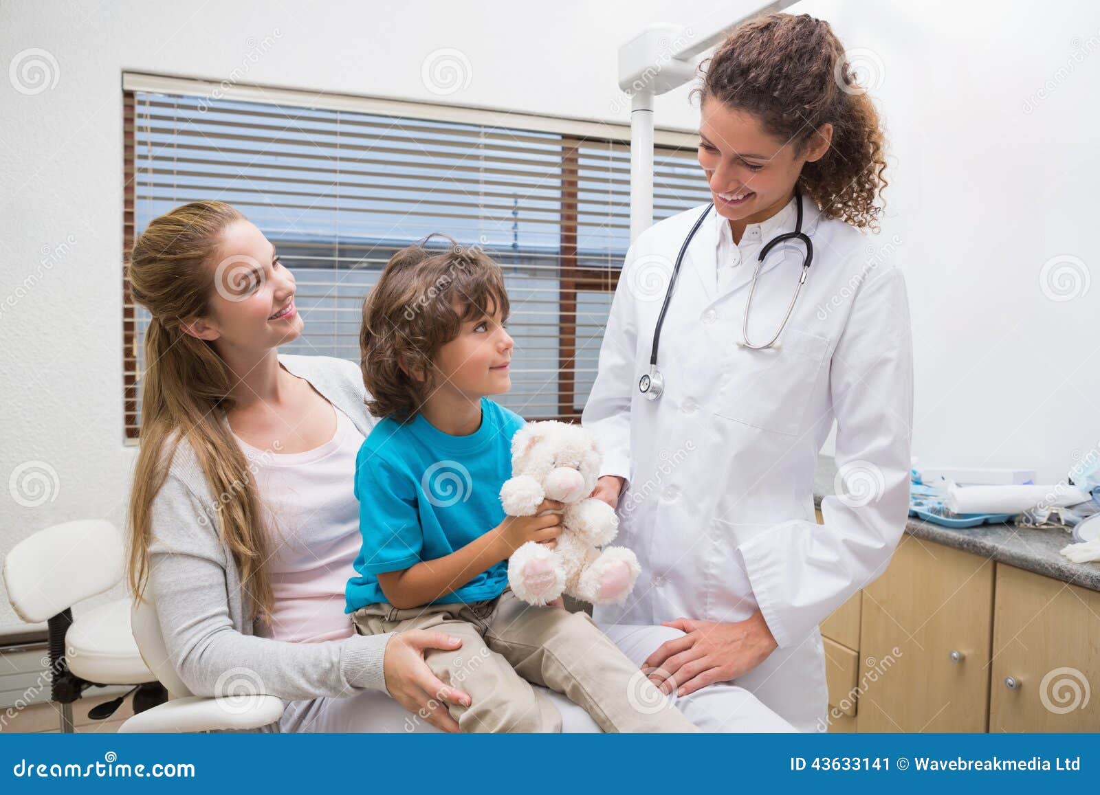 Pediatric Dentist Smiling at Little Boy with His Mother Stock Image ... Pediatric Dentist Smiling at Little Boy with His Mother Stock Image ...