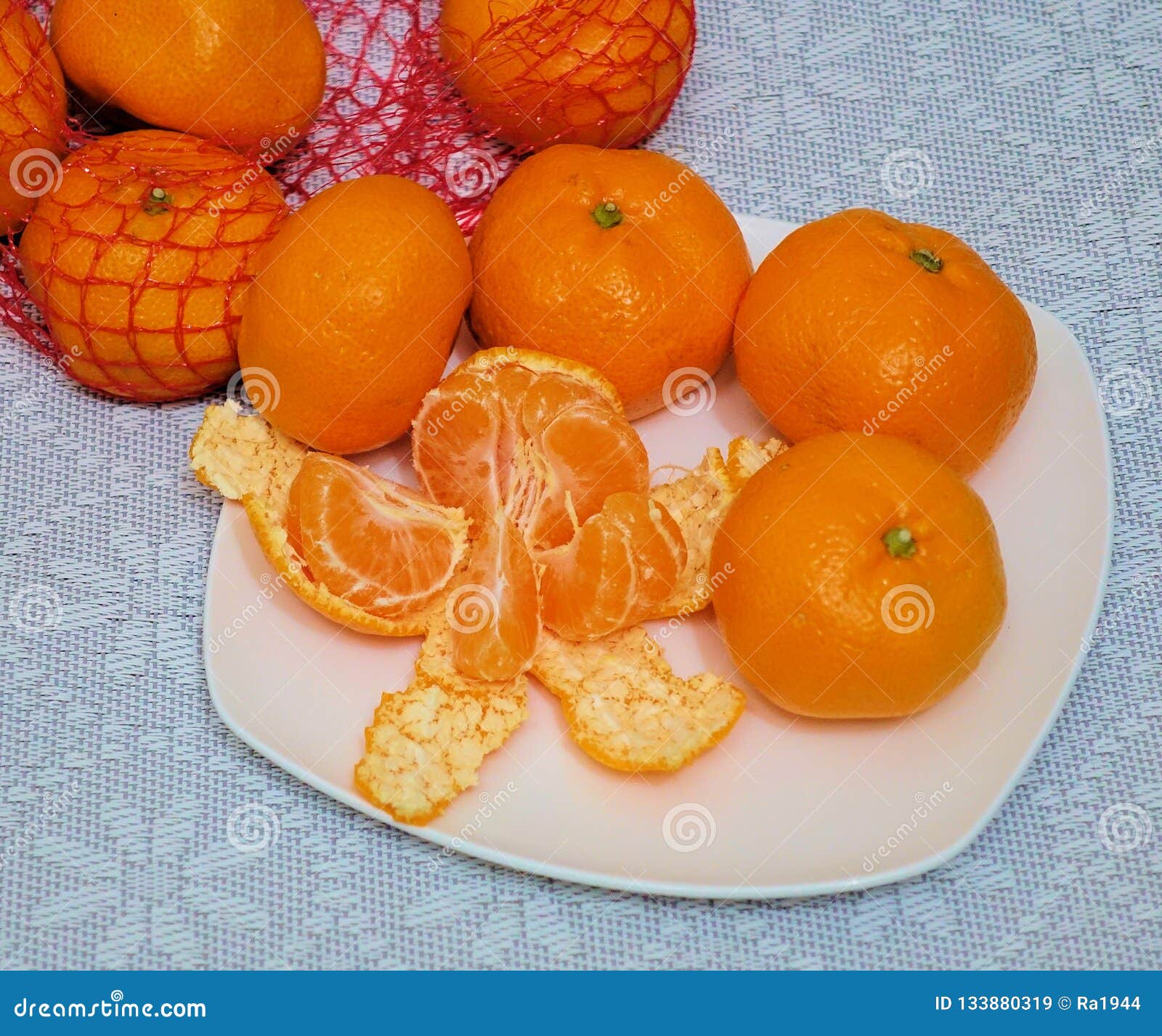 Peeled Mandarin Divided into Slices on a White Plate Stock Image ...