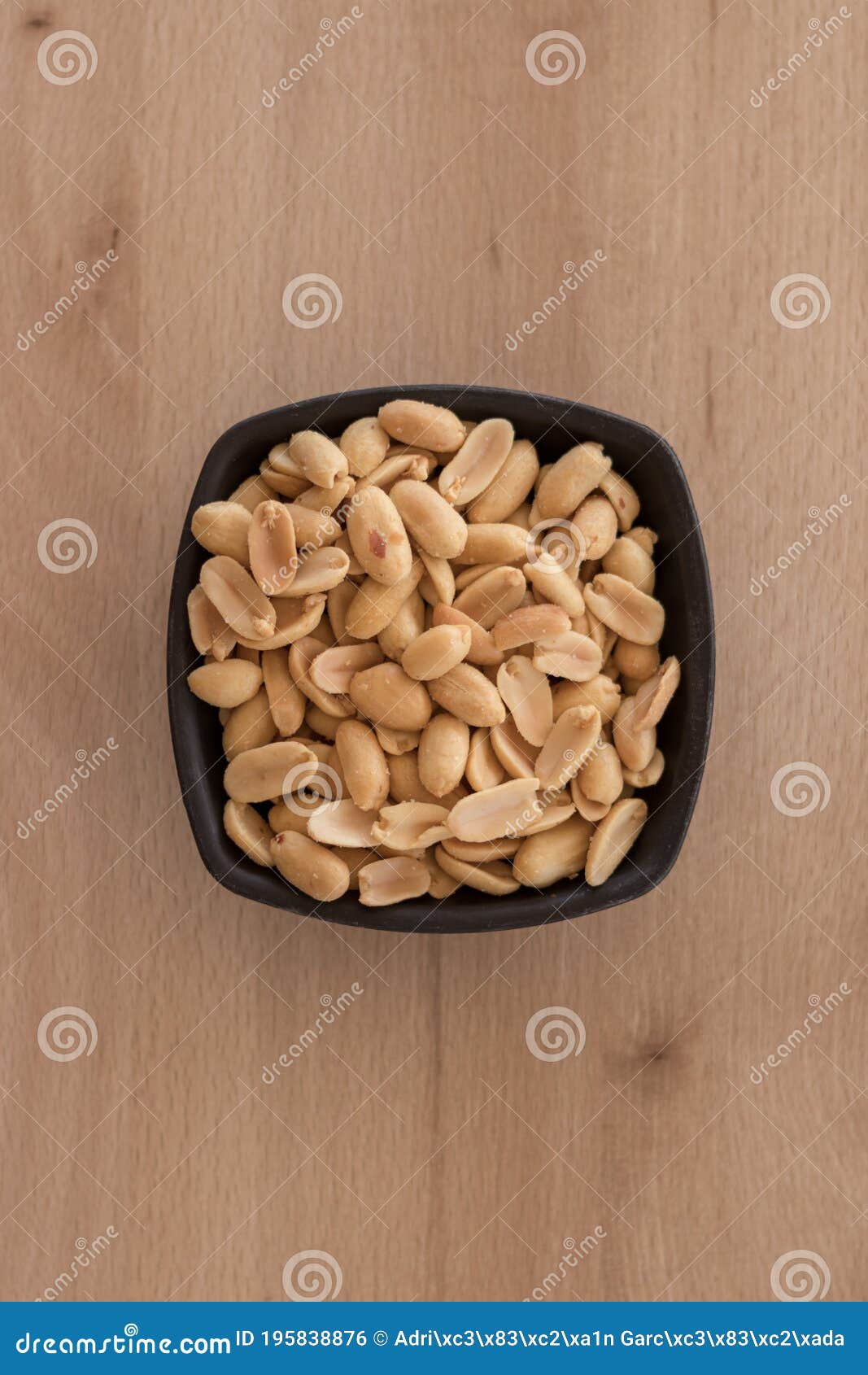Peanuts in a container stock photo. Image of black, salted - 195838876
