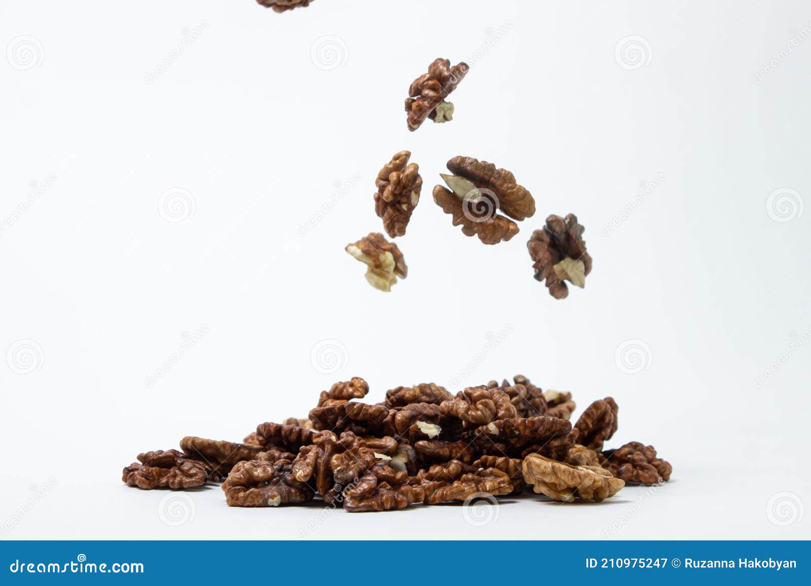 Peeled Walnuts on a White Background. a Peeled Walnut Falls Down Onto a ...