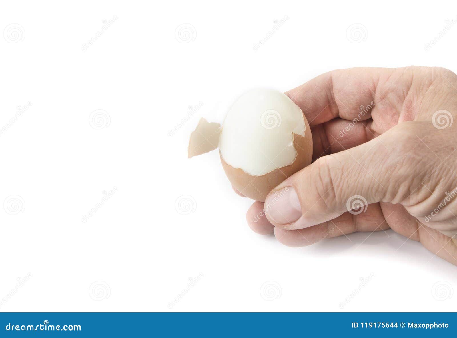 Peeling Off the Hard Egg Shell with Hands on the White. Stock Photo ...