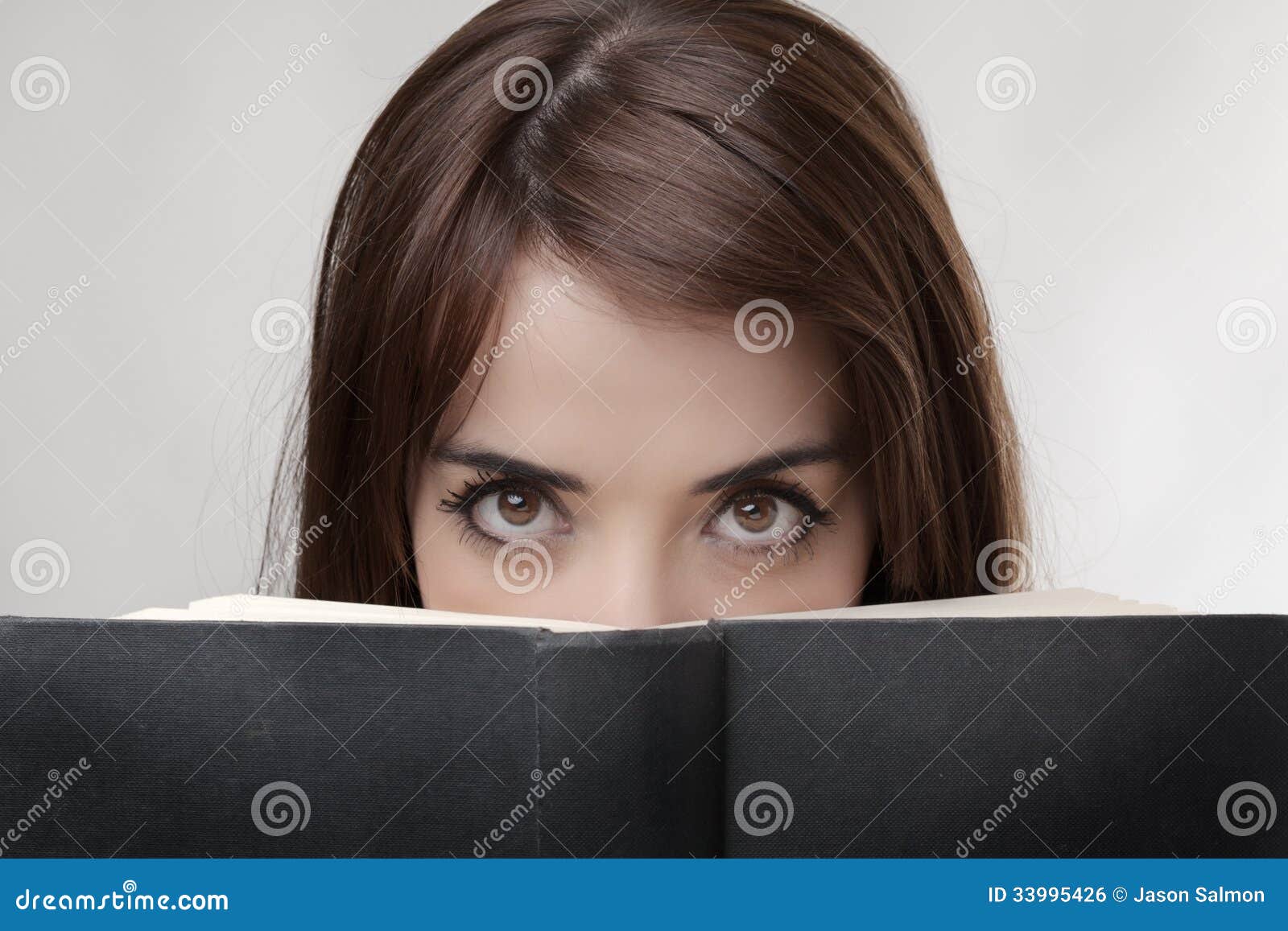 Peering over book stock photo. Image of gorgeous, portrait - 33995426