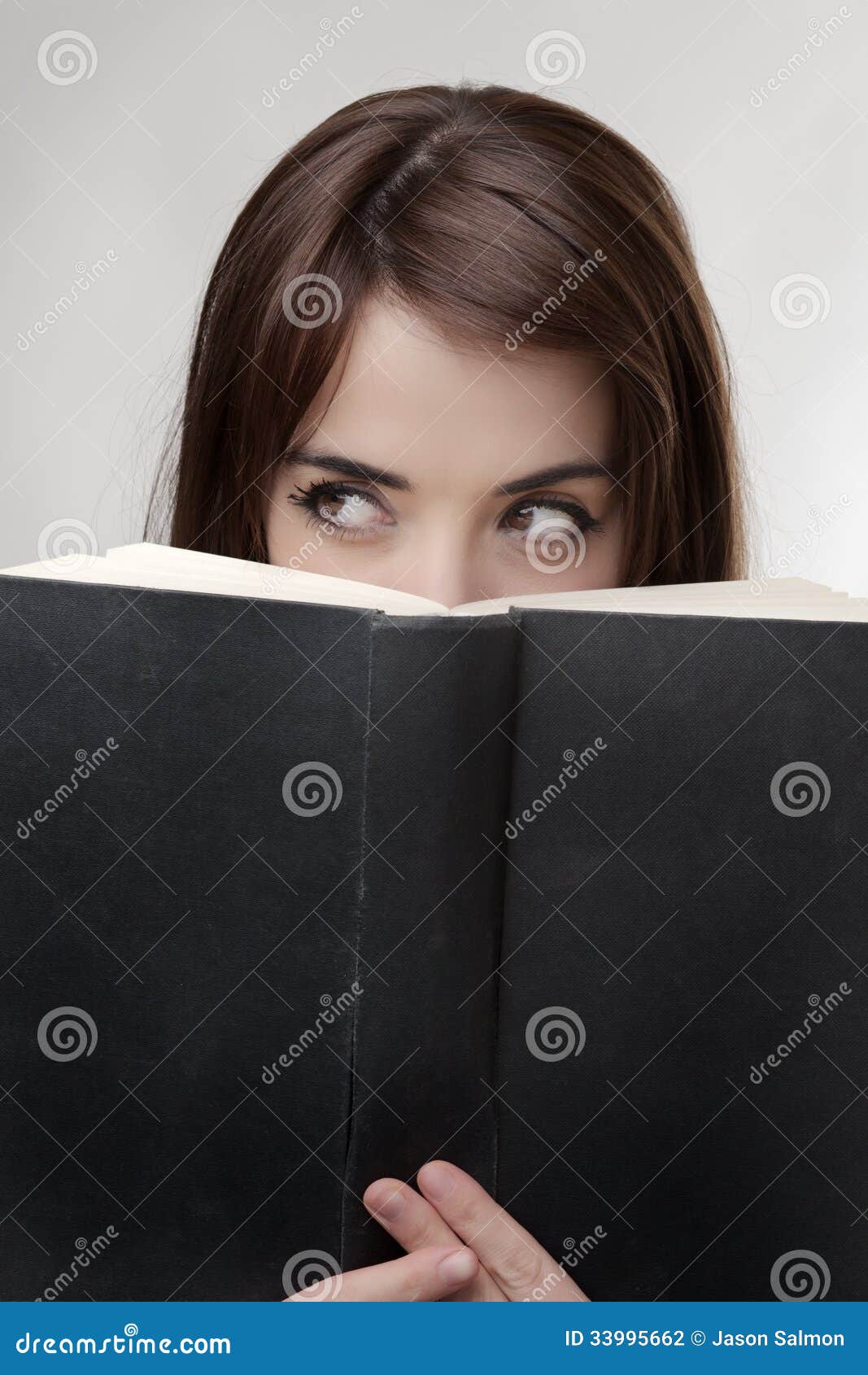 Peering over book stock photo. Image of novel, pretty - 33995662