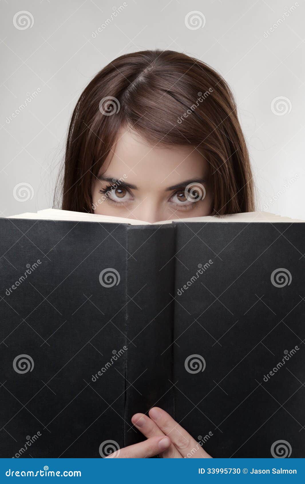 Peering over book stock photo. Image of female, learn - 33995730