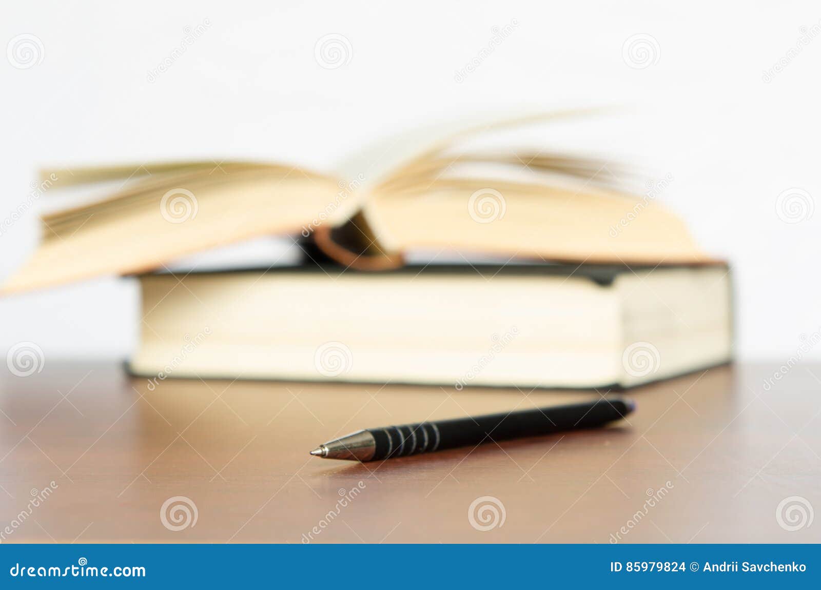 Pen on Background of a Stack of Colorful Books Stock Photo - Image of ...