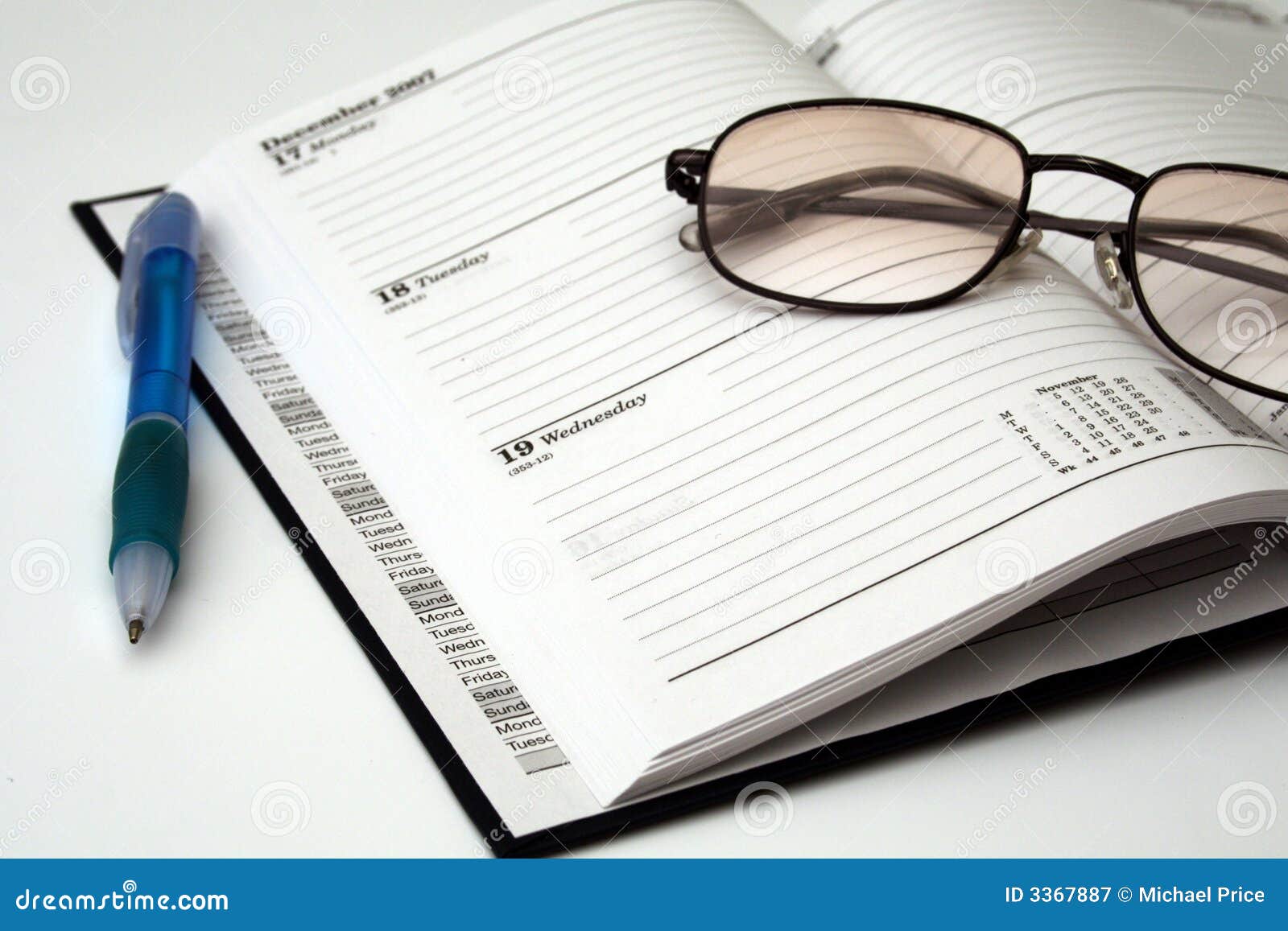 Pen and Glasses on a diary stock image. Image of information - 3367887