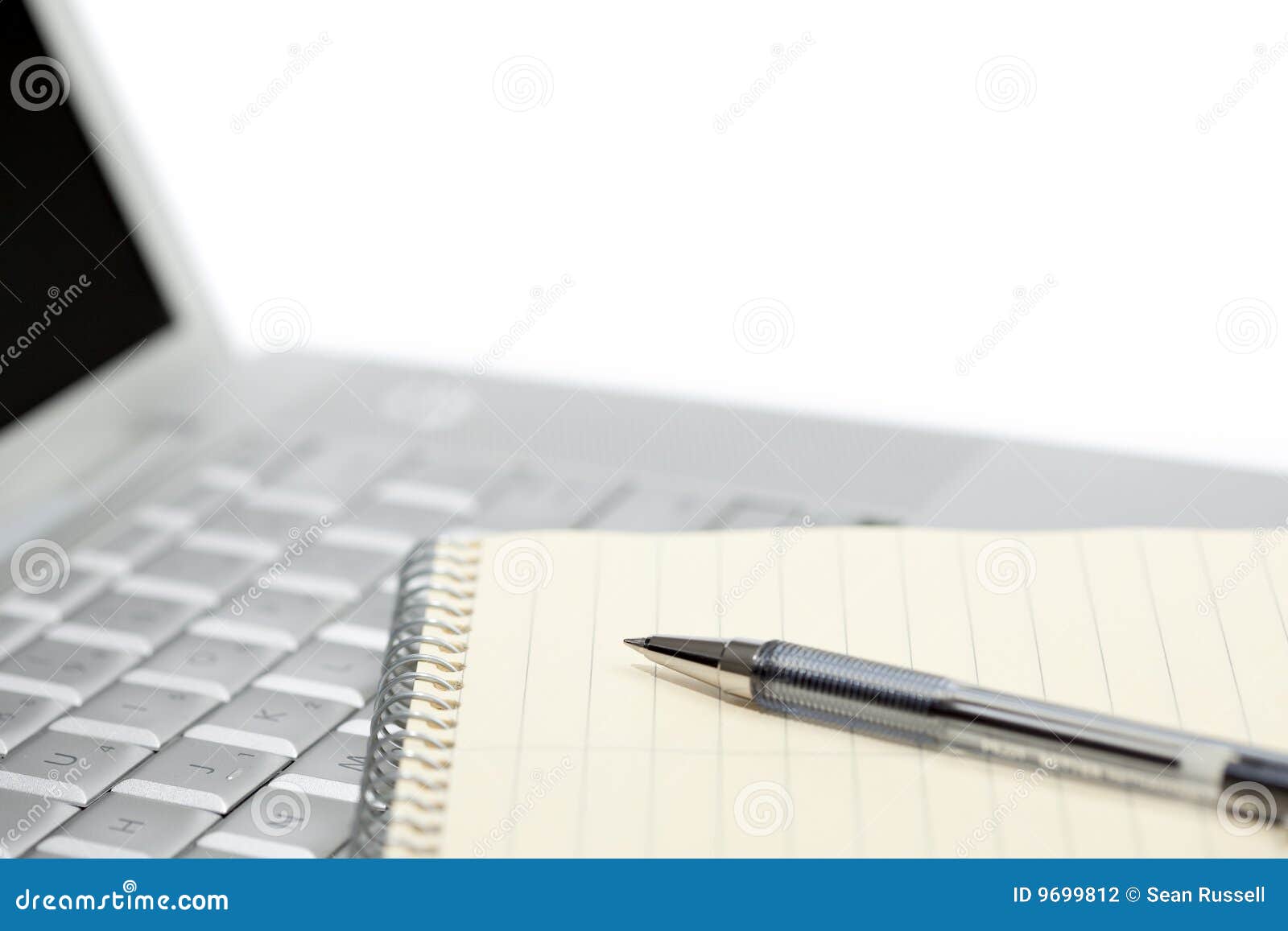 Pen and note pad on laptop stock photo. Image of studio - 9699812
