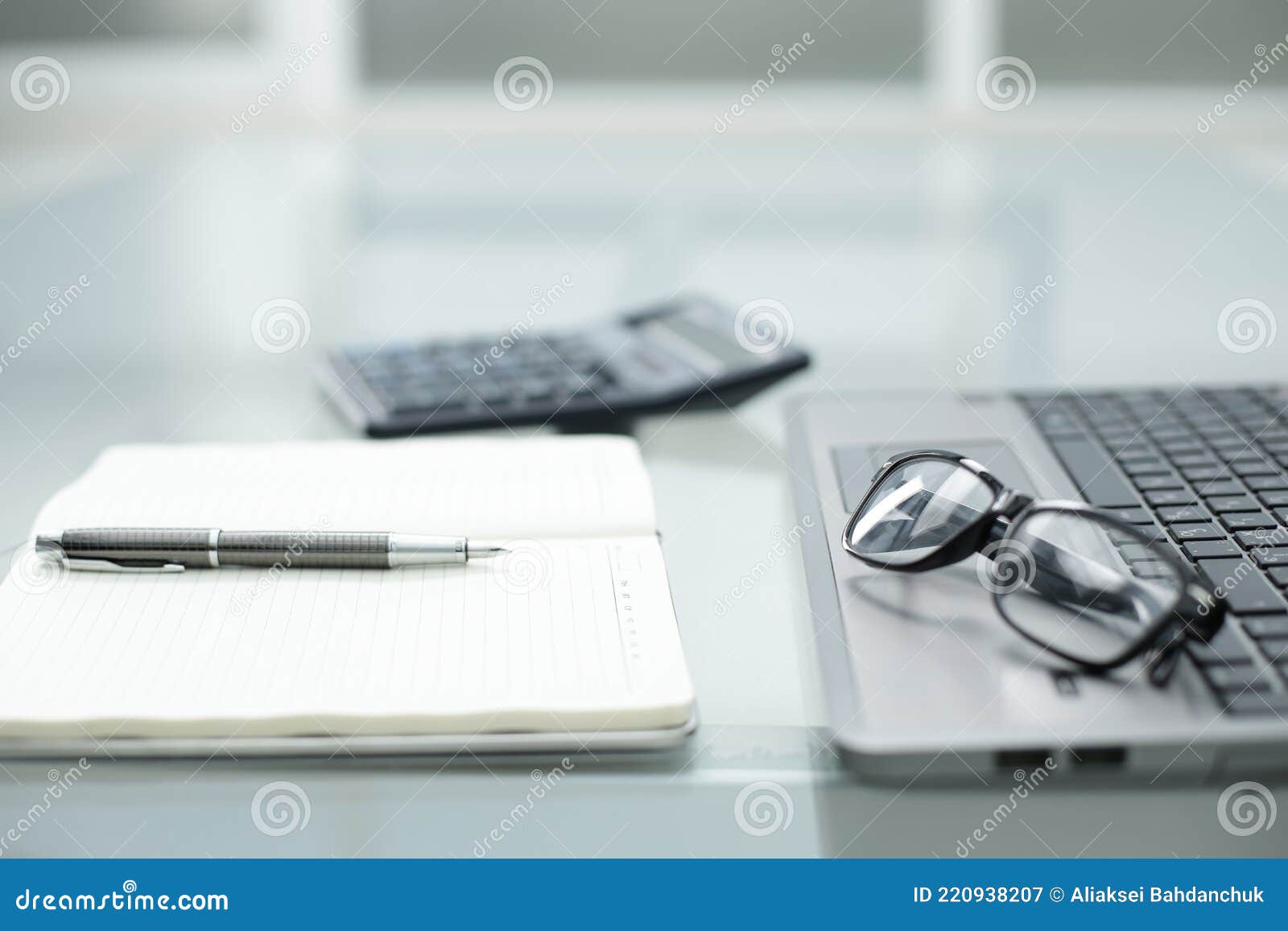 Pen Notepad Calculator Glasses Notebook on Glass Table Stock Image ...