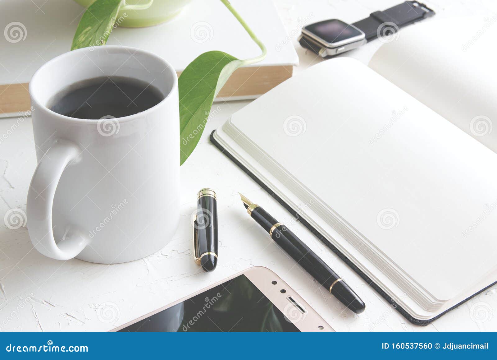 A Pen on a Paper Notebook Next a Book and a Mug with Some Coffee ...