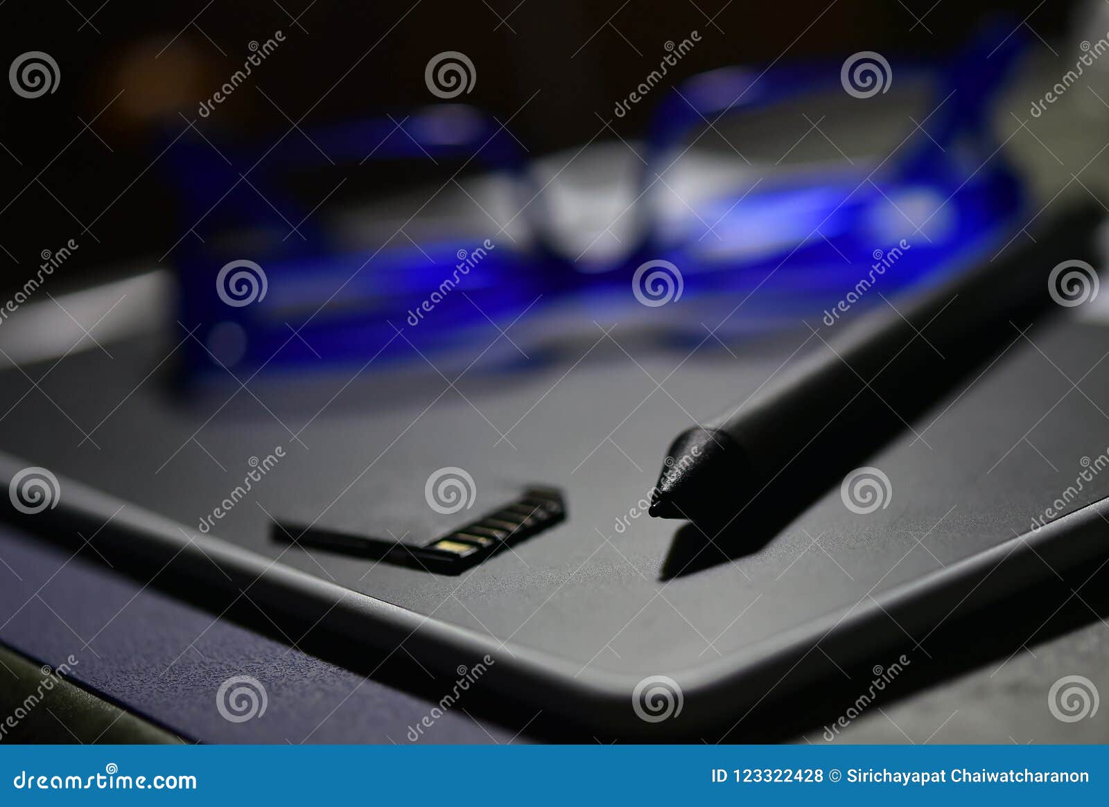 Pen and Tablets, Blue Eye Glasses and Memory Card Blur Stock Photo ...