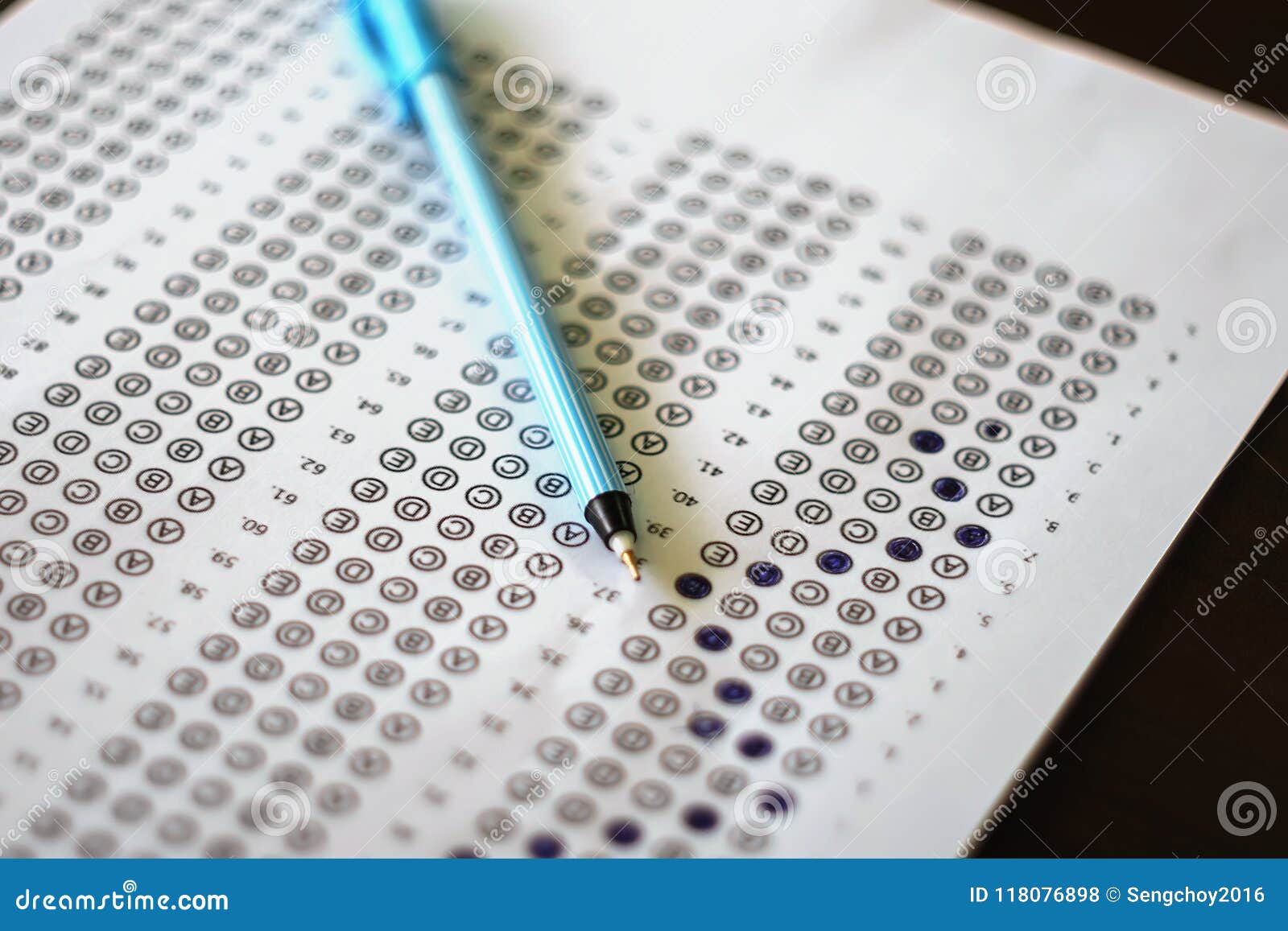 A Pen on White Answer Sheet for Multiple Choice Questions in ...