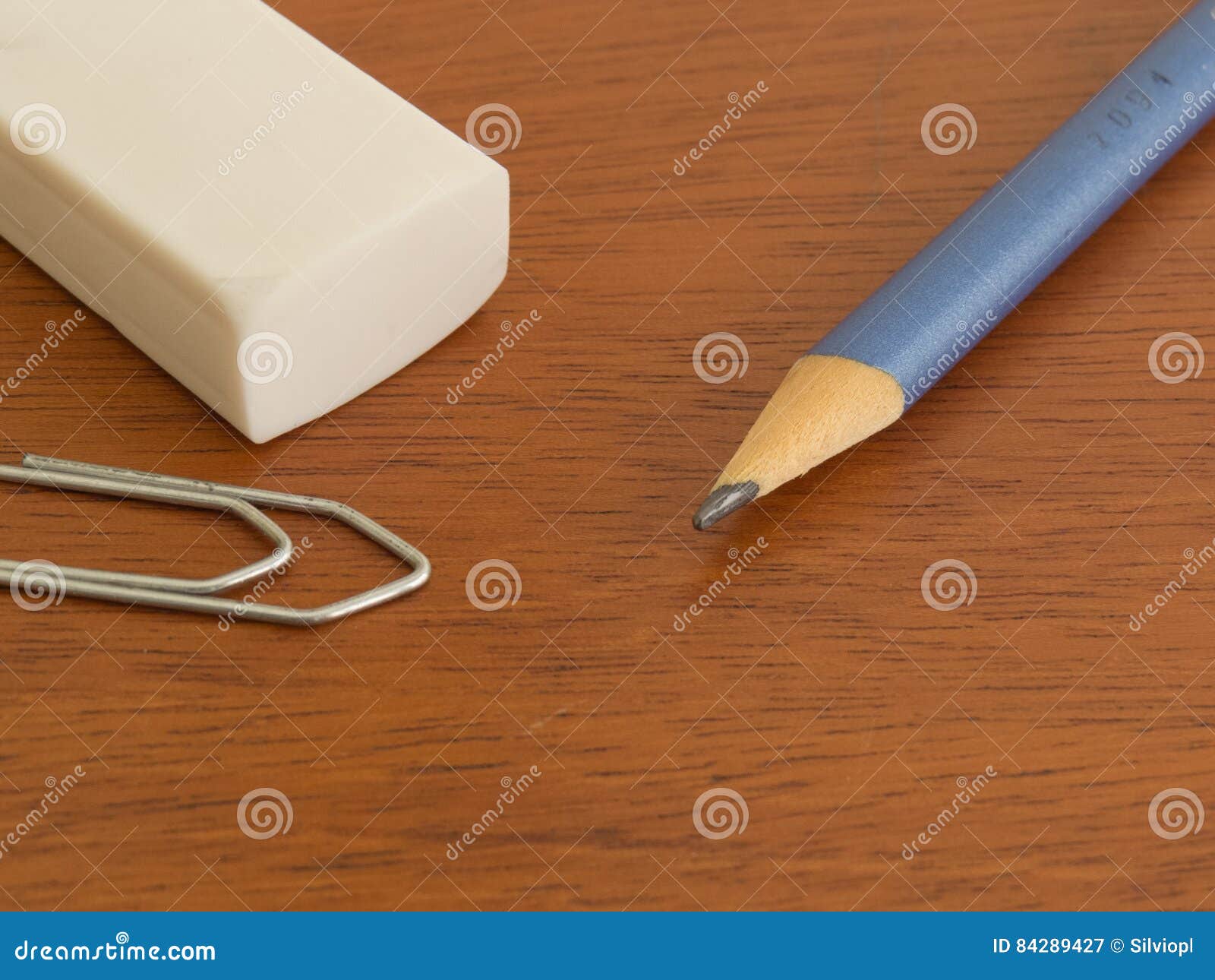 Pencil, Eraser and Clip on Wooden Table Stock Image - Image of ...