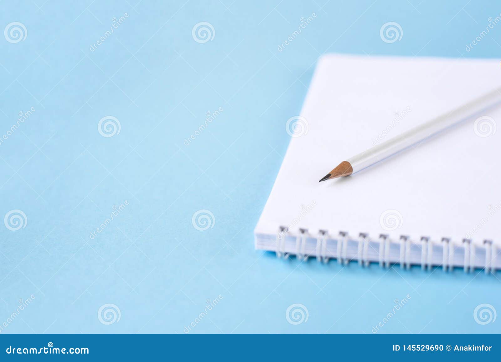 A Pencil and a Notebook on Blue Background Stock Photo - Image of blue ...