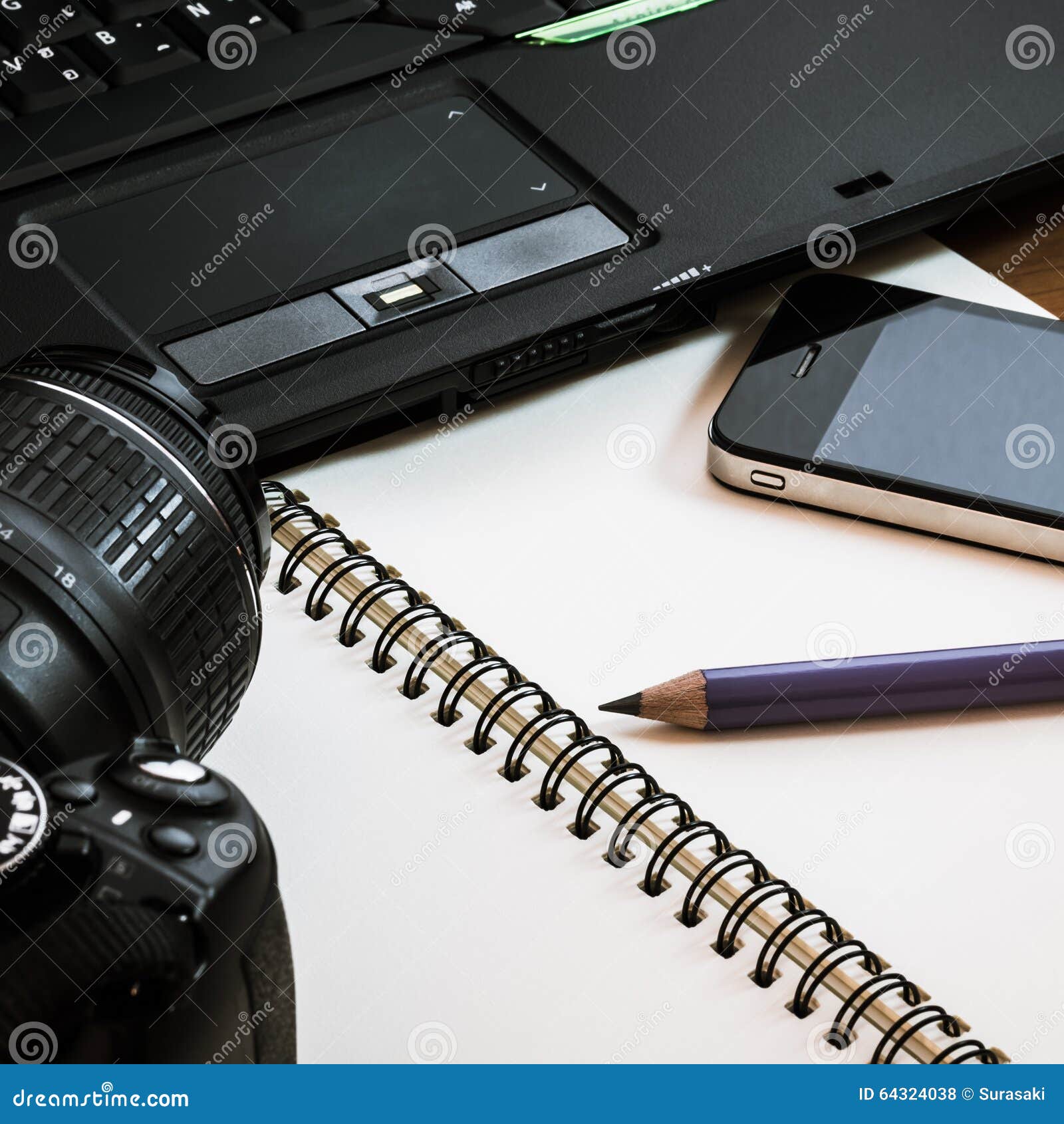 Pencil on Notebook with Camera, Laptop and Cell Phone Stock Photo ...