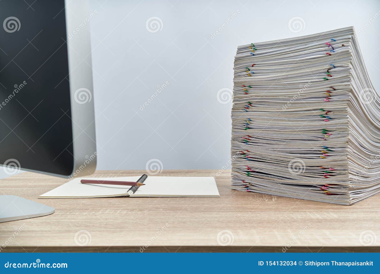 Pencil on Notebook with Overload Paperwork and Computer on Table Stock ...