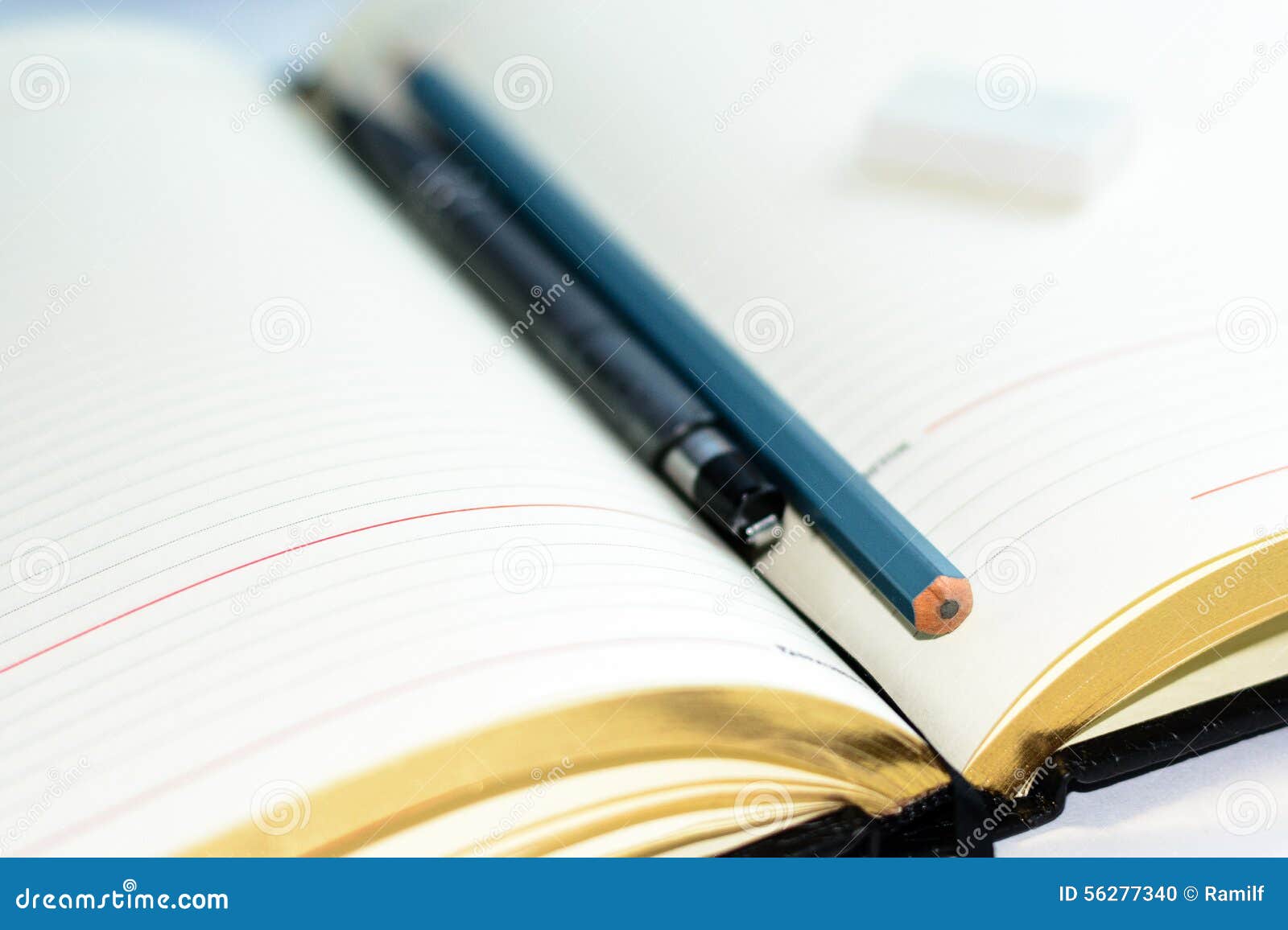 Pencil, Pen and Eraser Lying on an Open Notebook Stock Photo - Image of ...