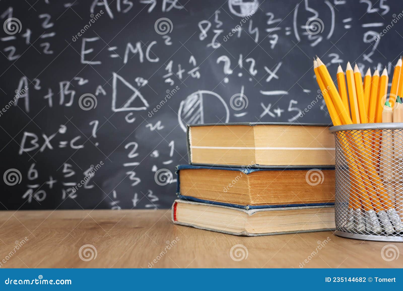 Pencils and Books Infront of Blackboard with Formulas. Education ...