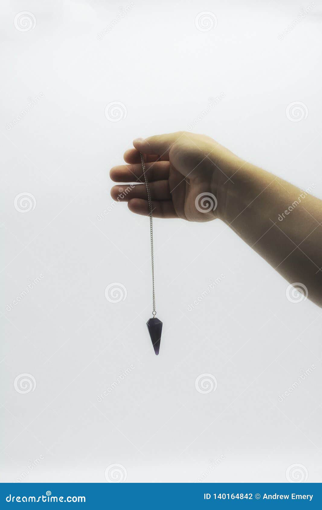 Pendulum Dowsing On An Isolated White Background With An Blue Crystal ...