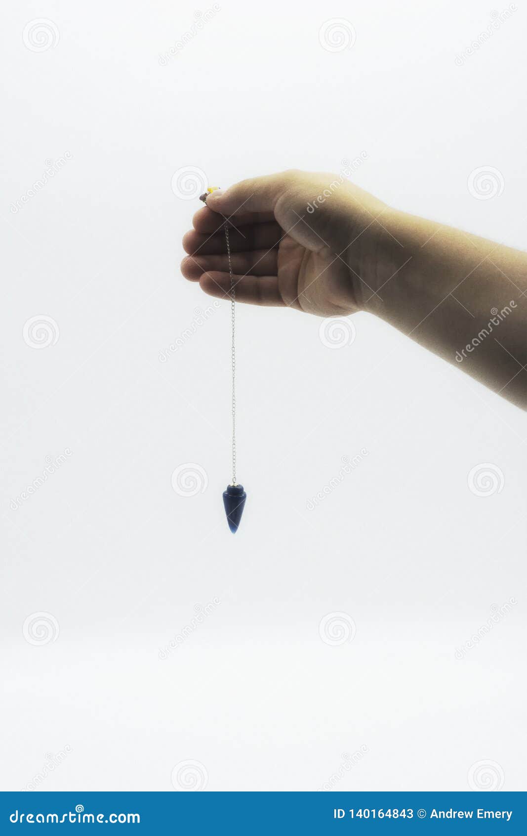 Pendulum Dowsing on an Isolated White Background with an Blue Crystal ...