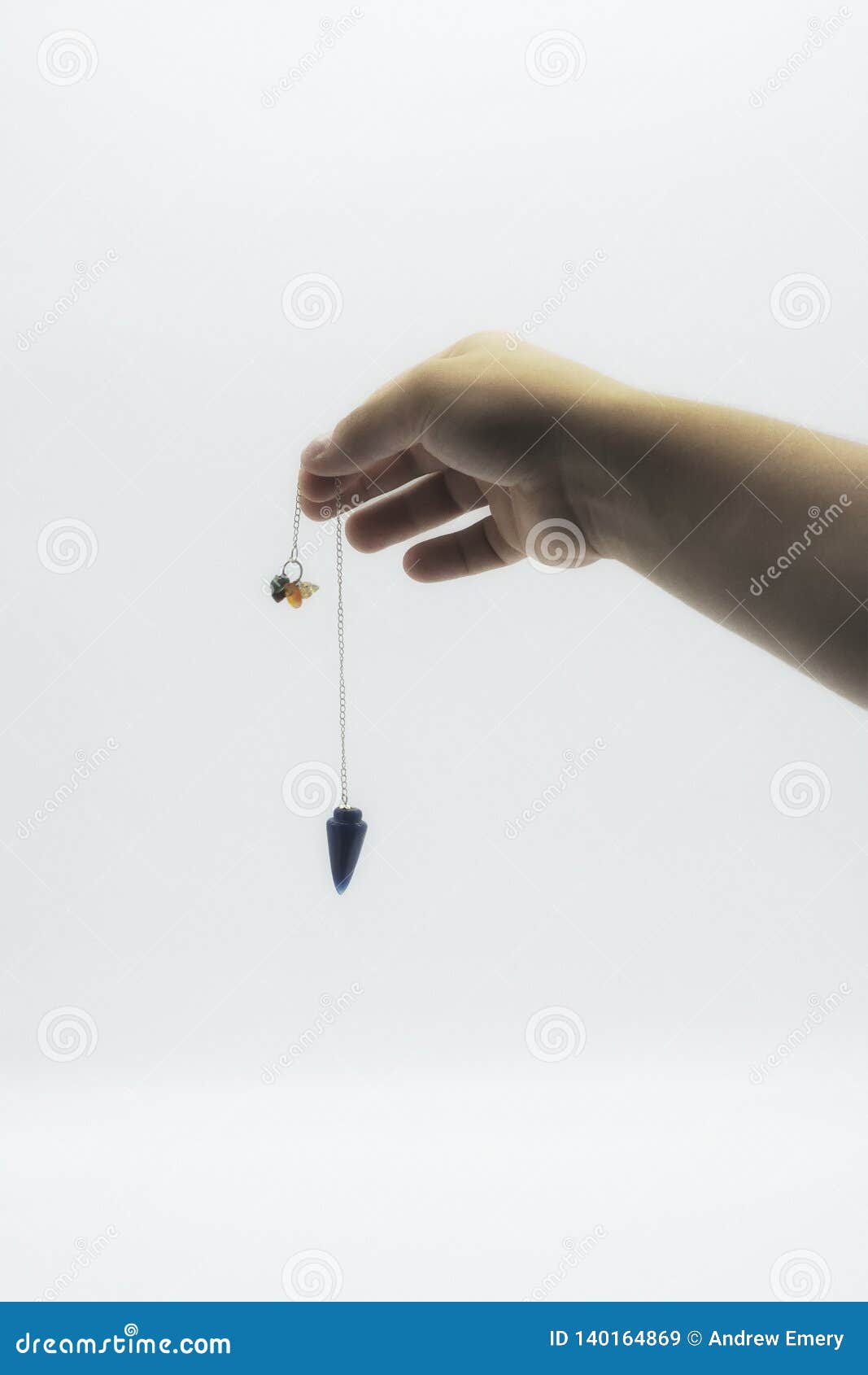 Pendulum Dowsing on an Isolated White Background with an Blue Crystal ...